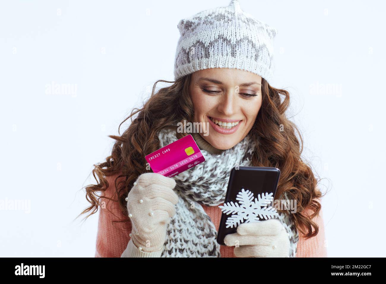 Hello winter. smiling modern woman in sweater, mittens, hat and scarf ...