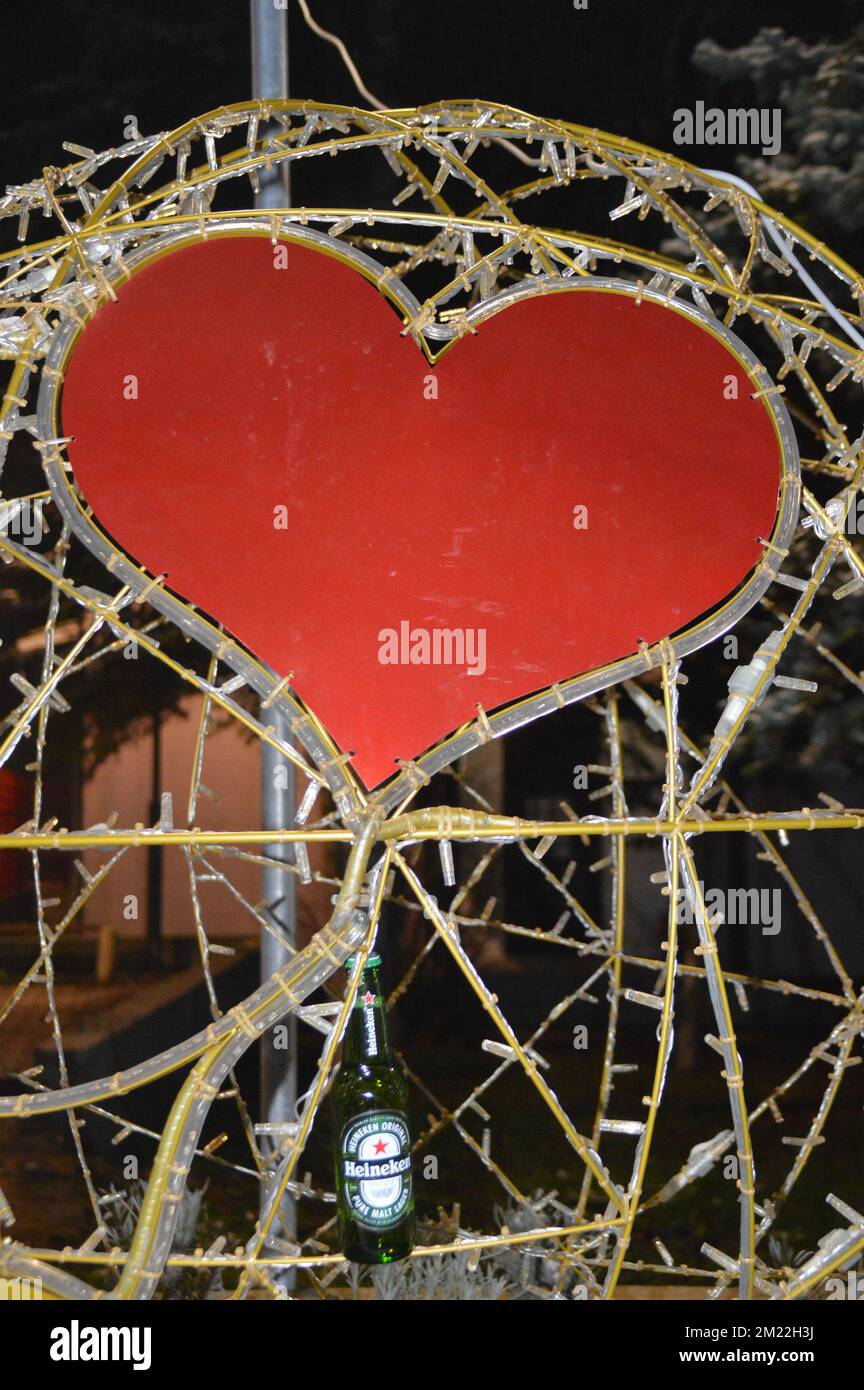 A decorative element of a heart and a bottle of Heineken beer Stock ...