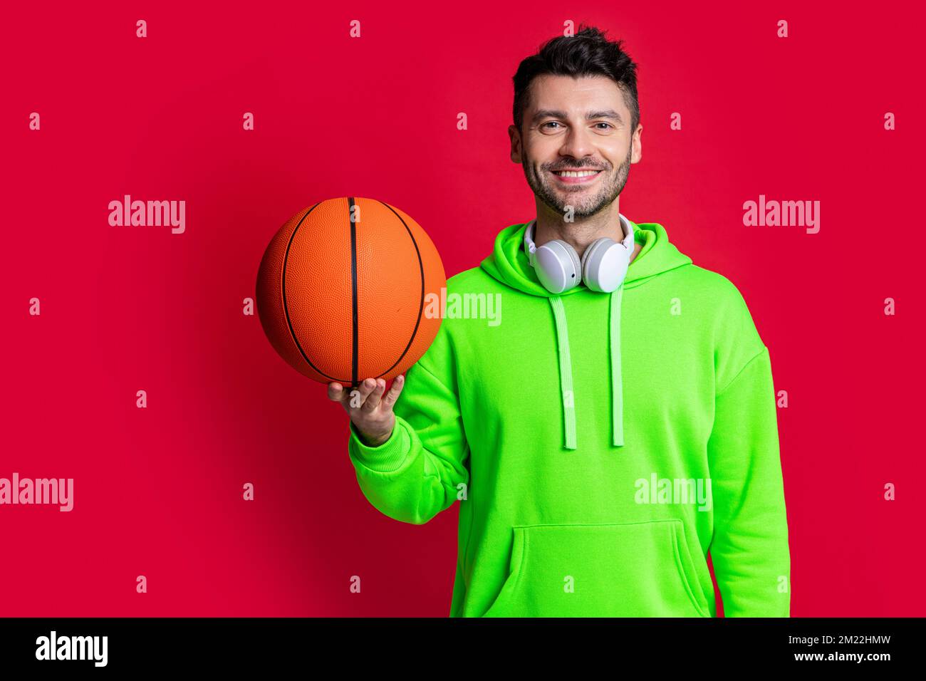 Happy man holding basketball ball studio. Basketball player smiling ...