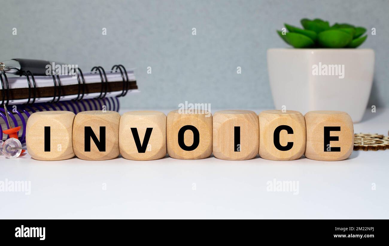 INVOICES word written on wood block. INVOICES text on wooden table for ...