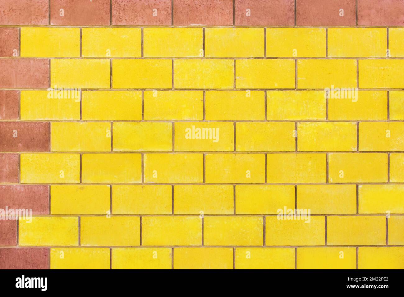 Yellow paint on a bright brick blocks urban color wall texture ...