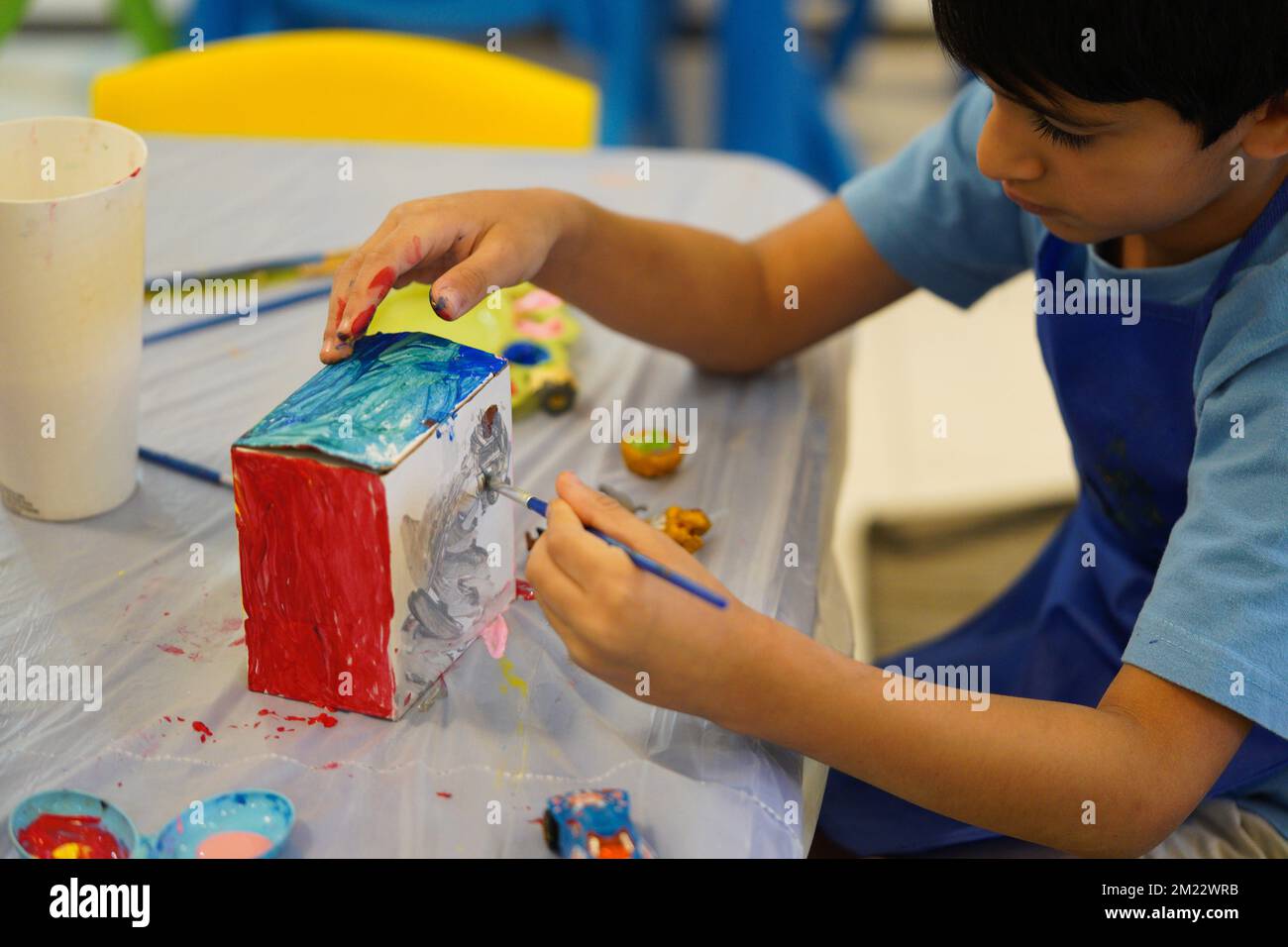 Little children painting a cube with multi colours, beautiful kids ...