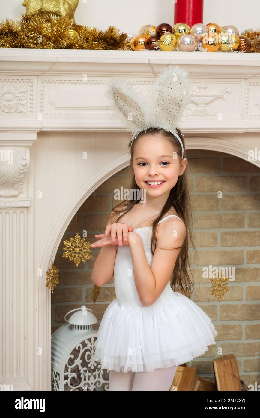 Little girl in fairy pixi costume dress with rabbite ears is posing ...