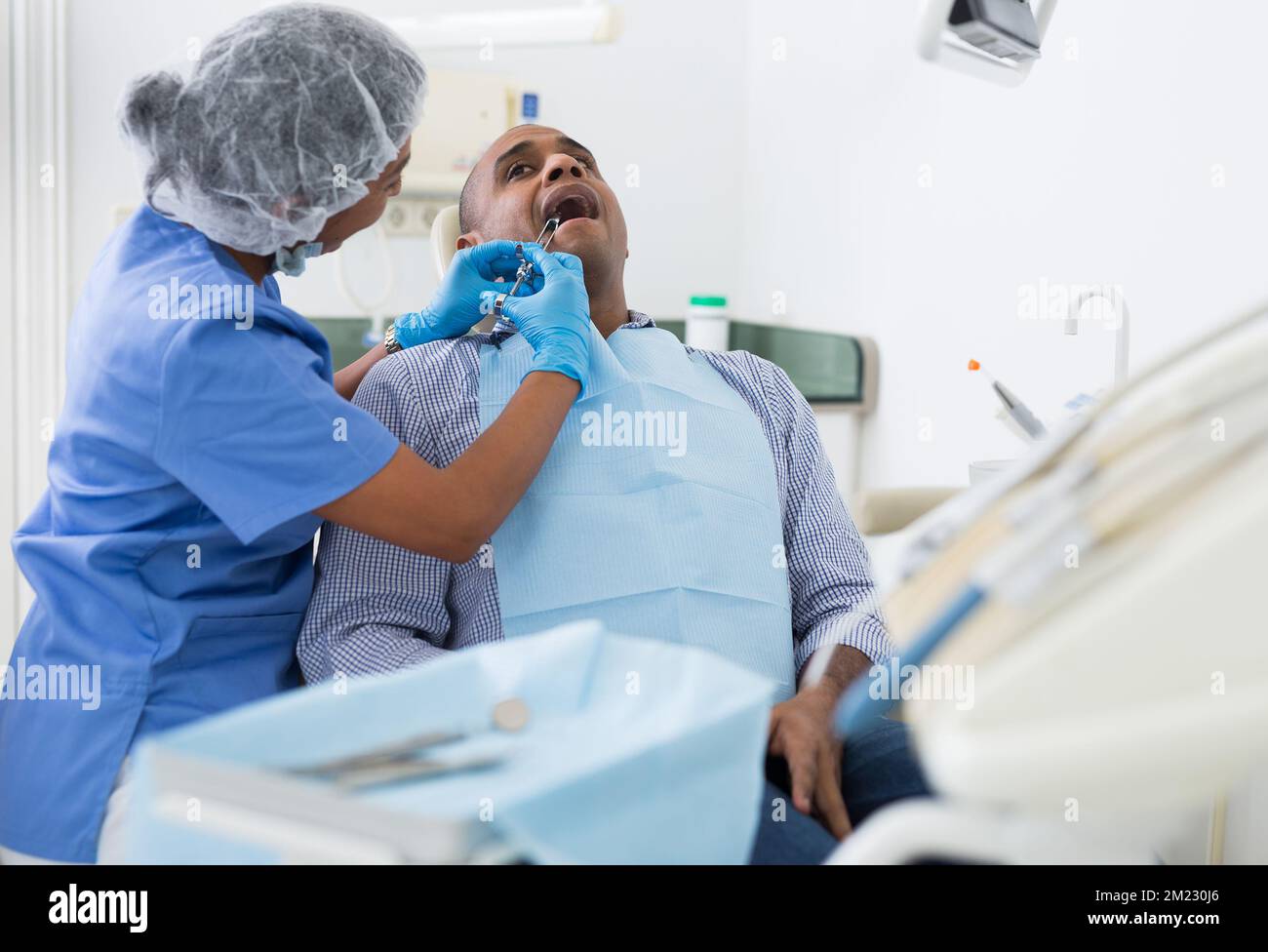 Man getting anesthetic injection before teeth treatment Stock Photo - Alamy
