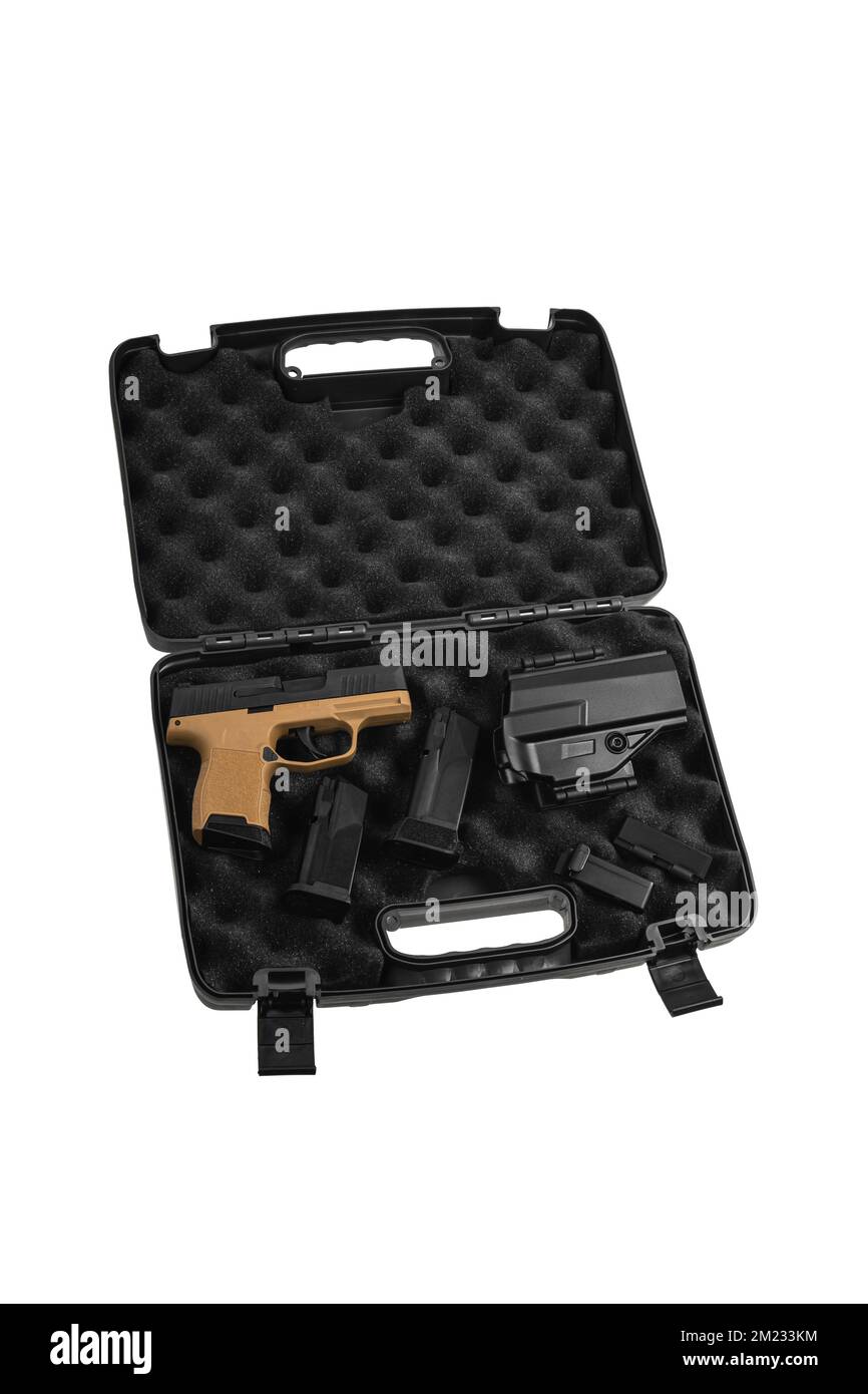 A modern small semi-automatic pistol with a holster and additional ammo ...
