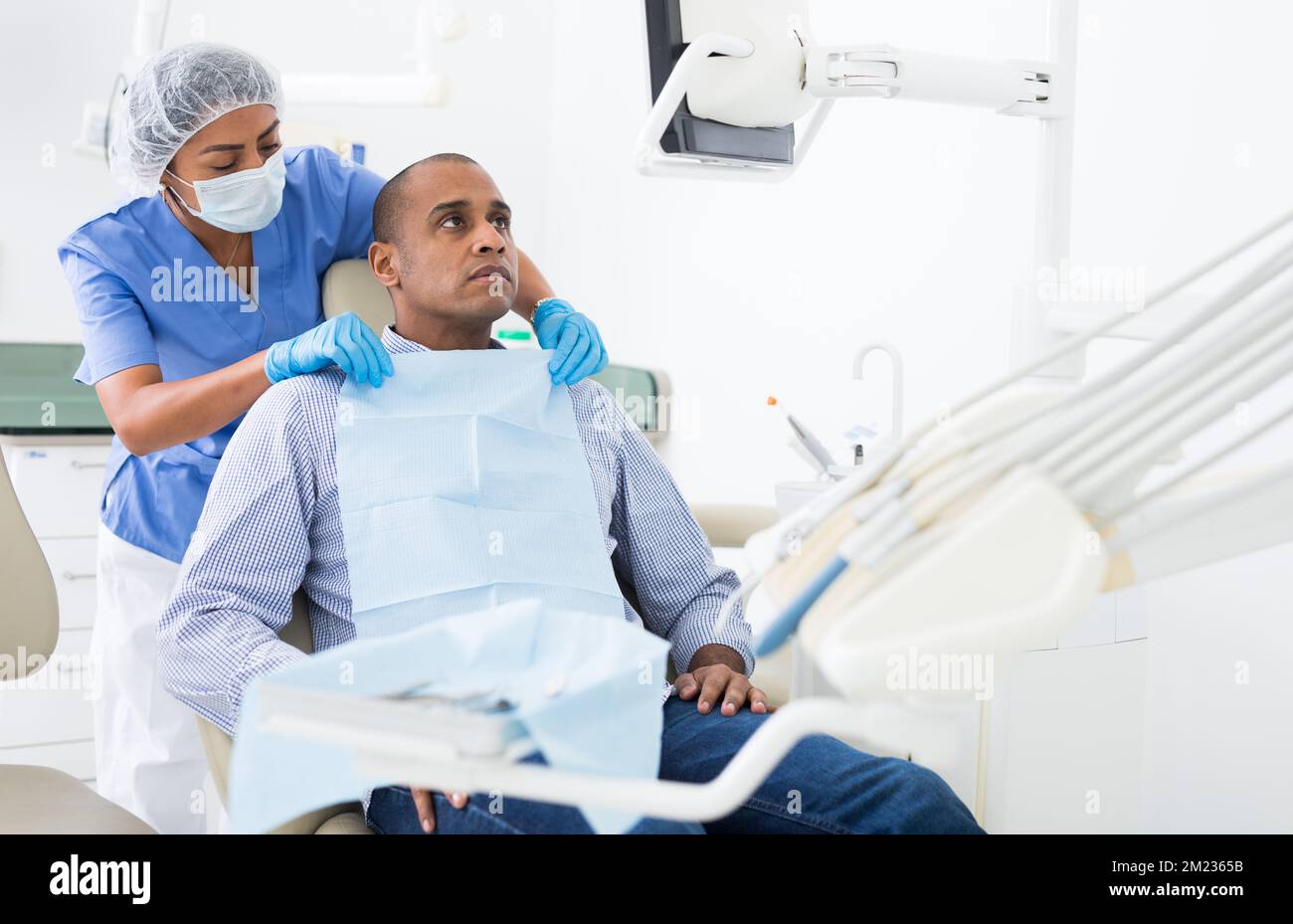 Dental assistant prepares patient for surgery Stock Photo - Alamy