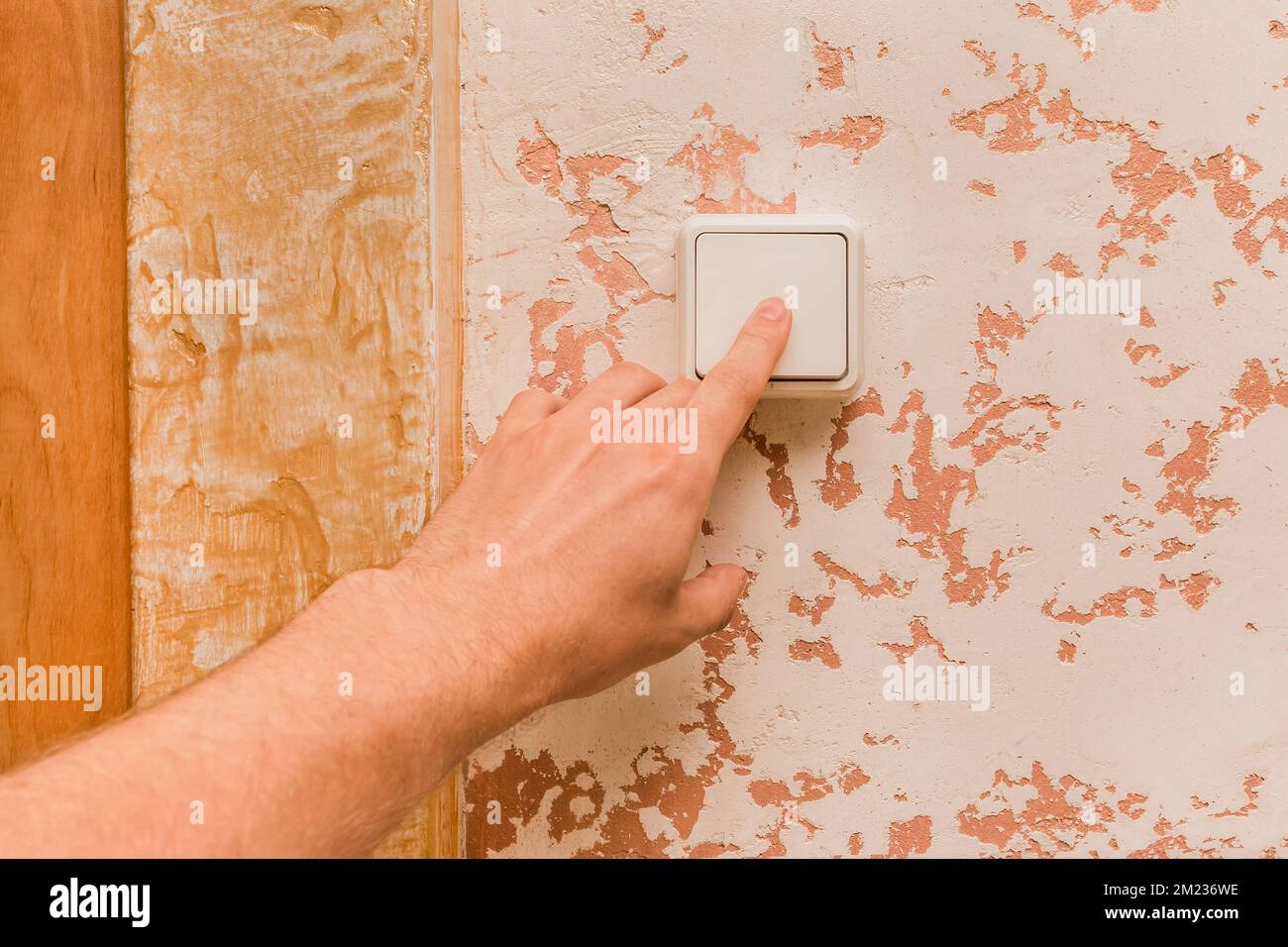 The guy's hand turns off the light with an electric switch in a modern ...