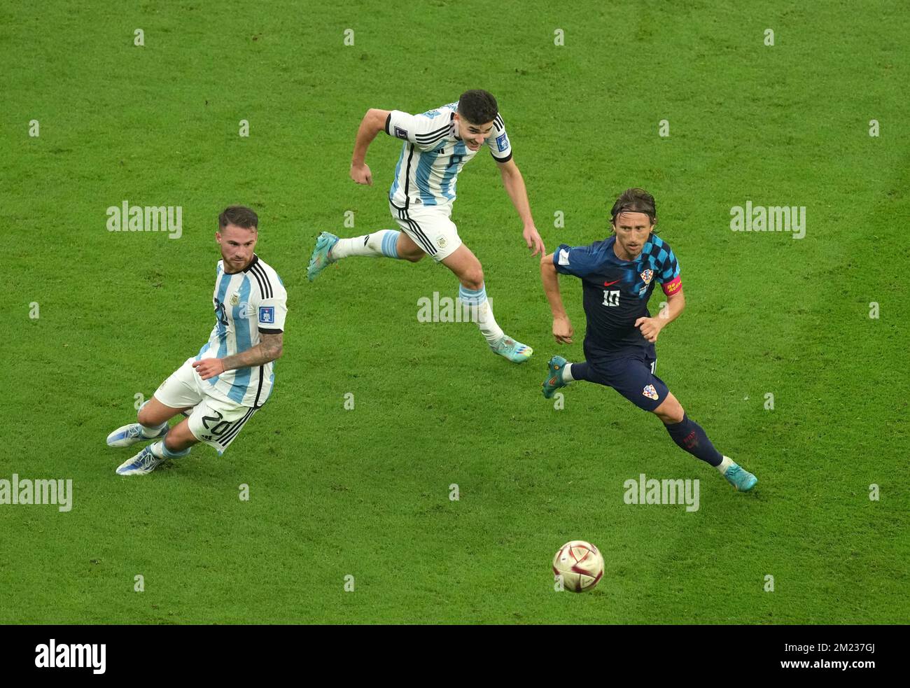 Argentina's Alexis Mac Allister,Julian Alvarez and Croatia's Luka Modric (left-right) in action ...