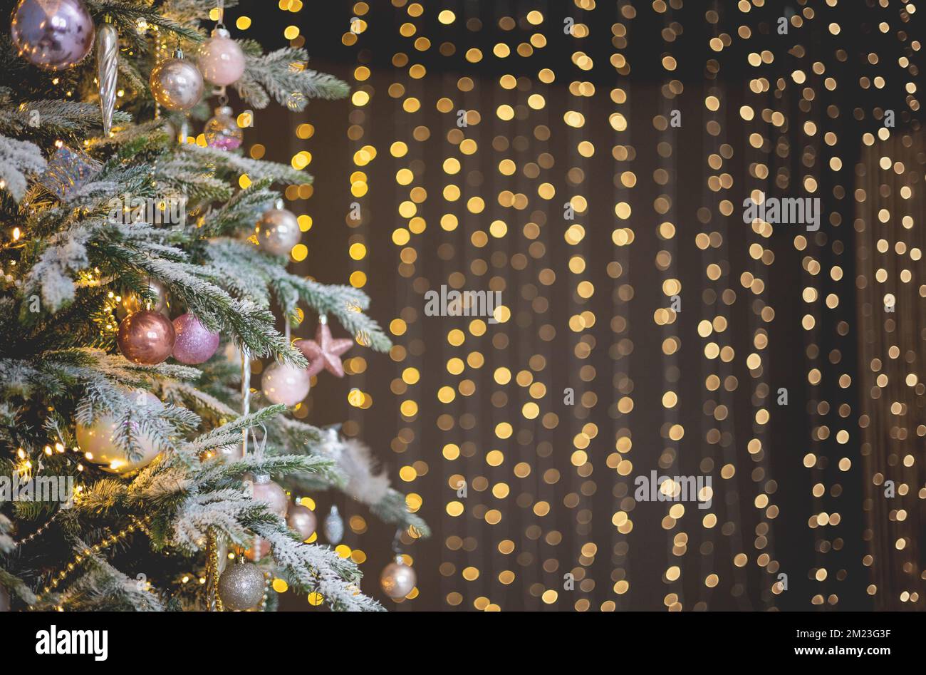 Festive decorated Christmas tree fluffy branches covered by snow and ...