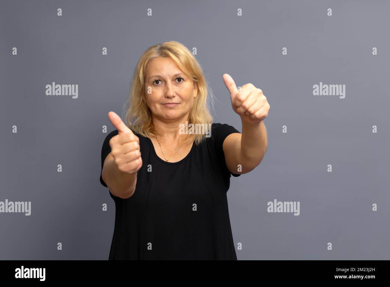 Pretty caucasian blonde woman in casual clothes approving doing ...