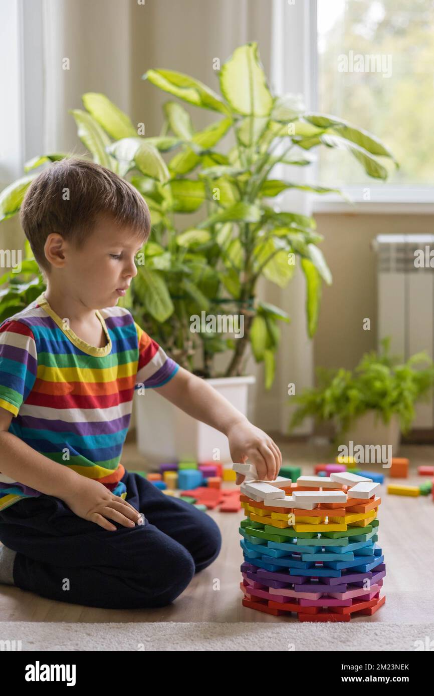 Baby boy construction colored wooden cubes block brick circle tower ...