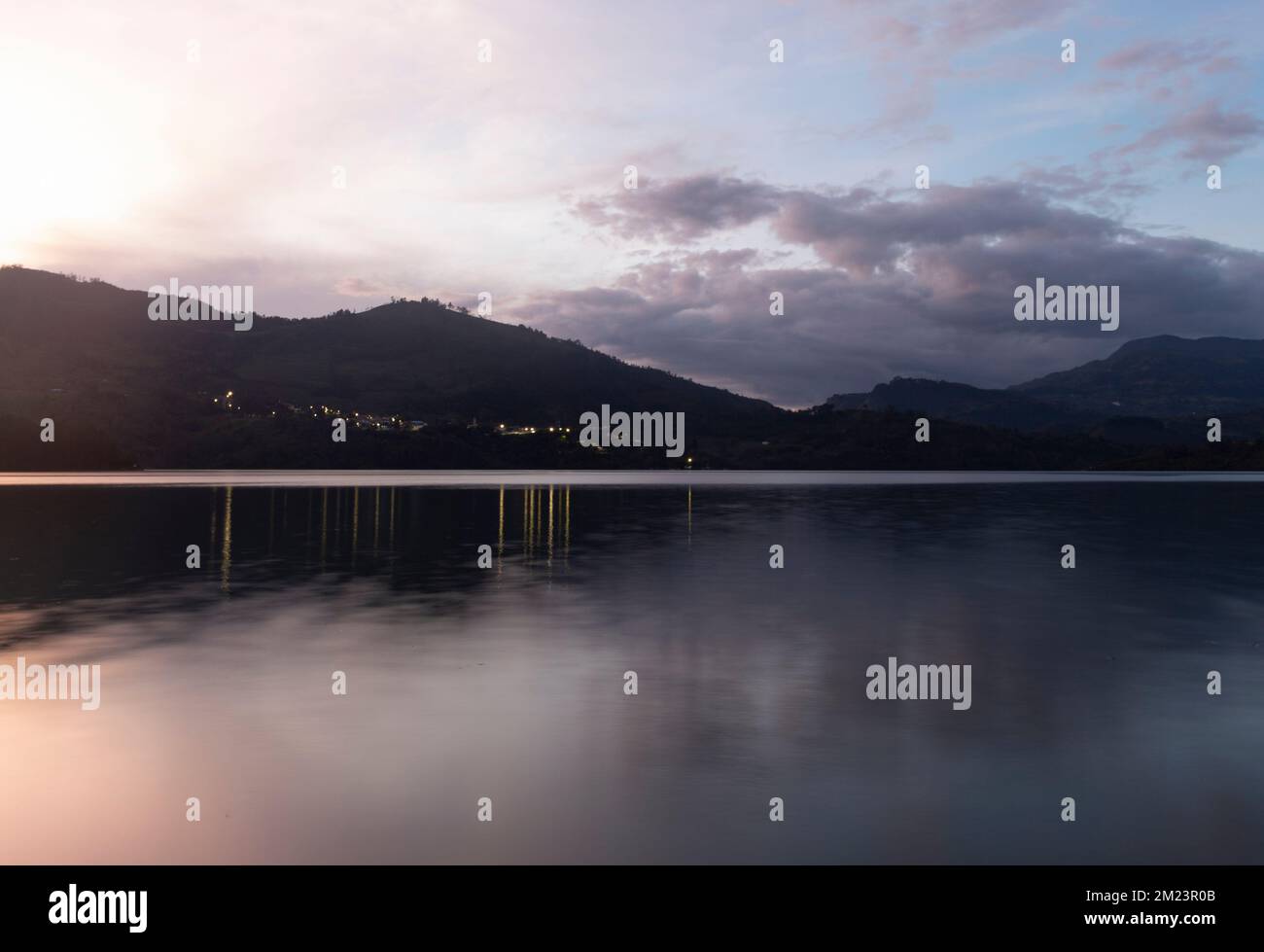 Colombian Gachala town viewed from guavio reservoir in colorful sunset ...