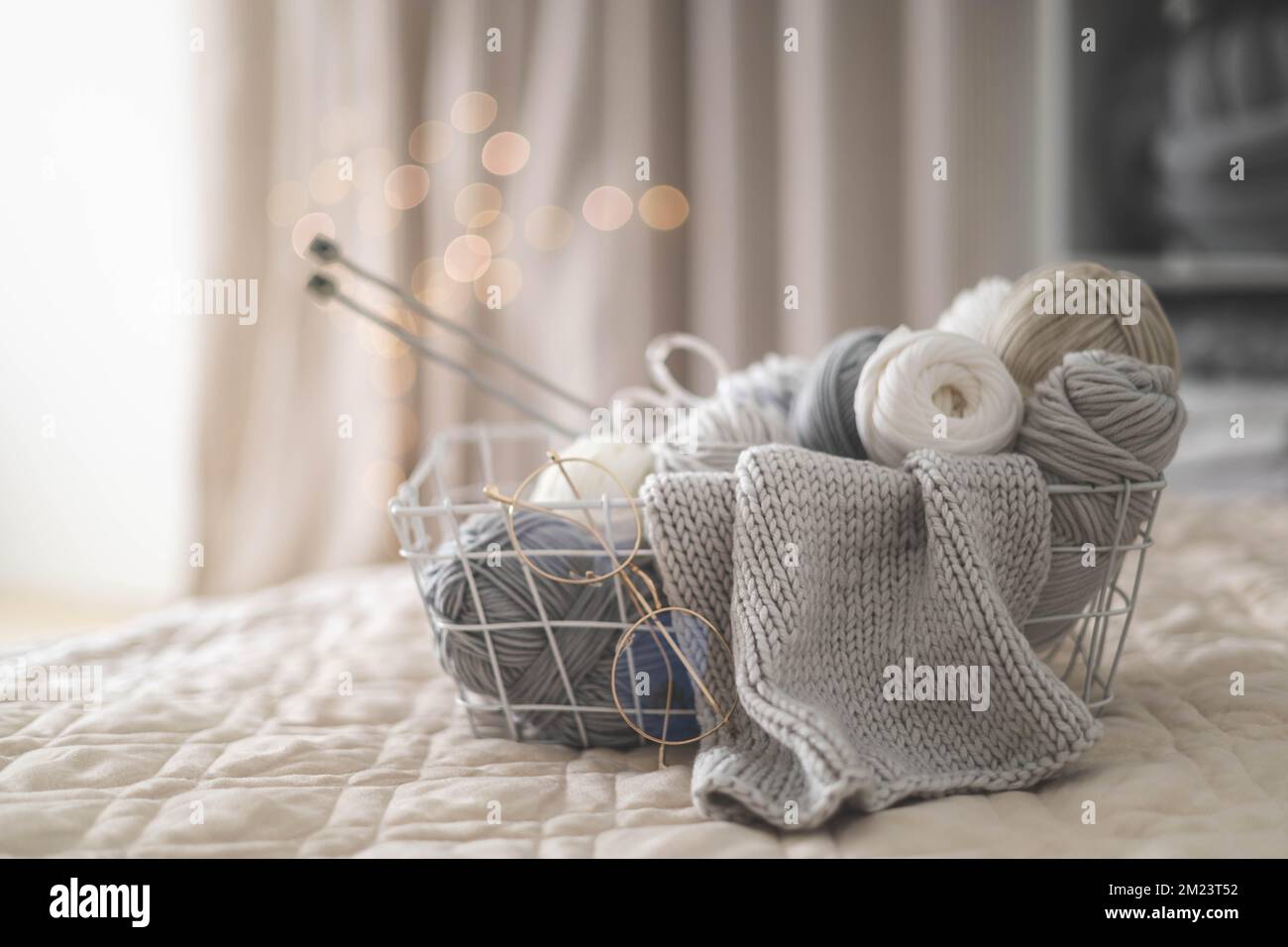 Cozy homely atmosphere. Female hobby knitting. Yarn in neutral colors ...