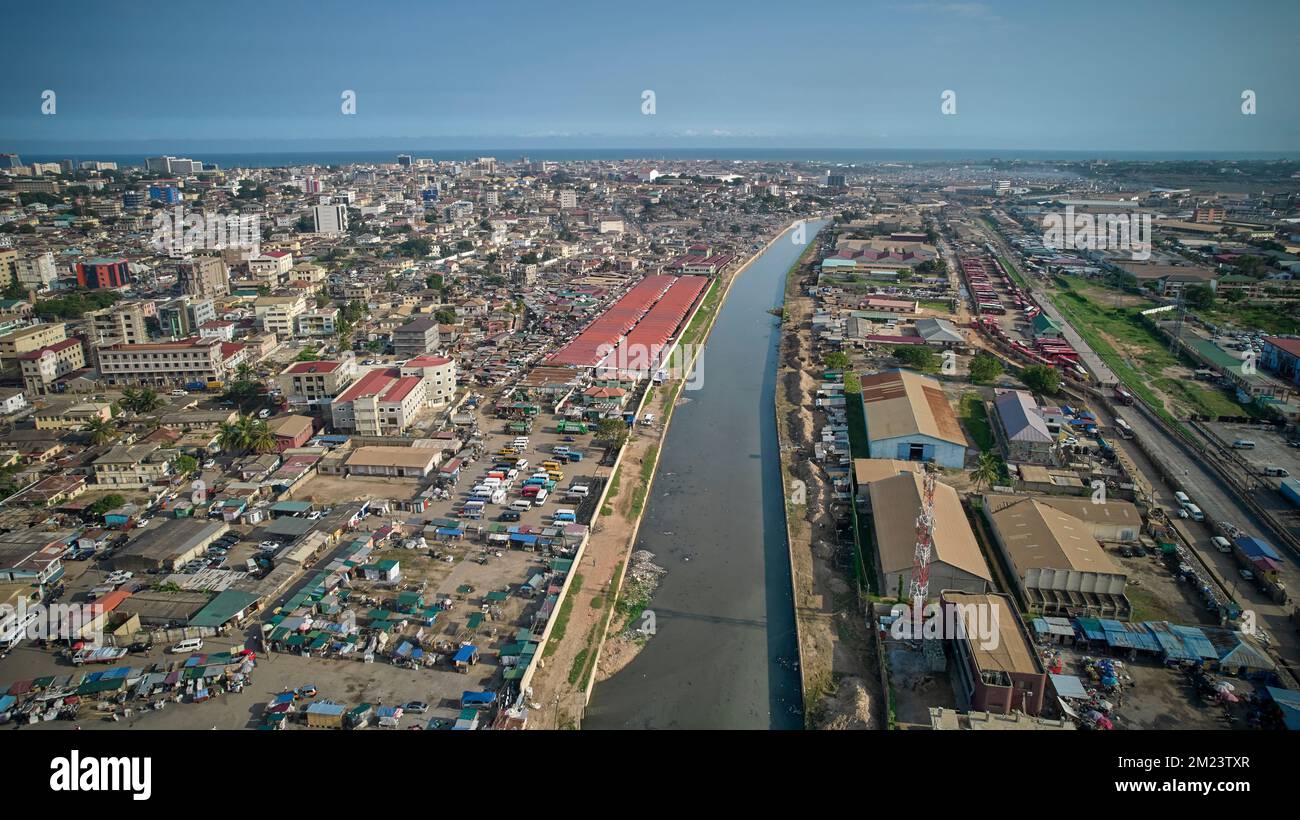 A bird's eye view of a water canal flows between residential districts ...