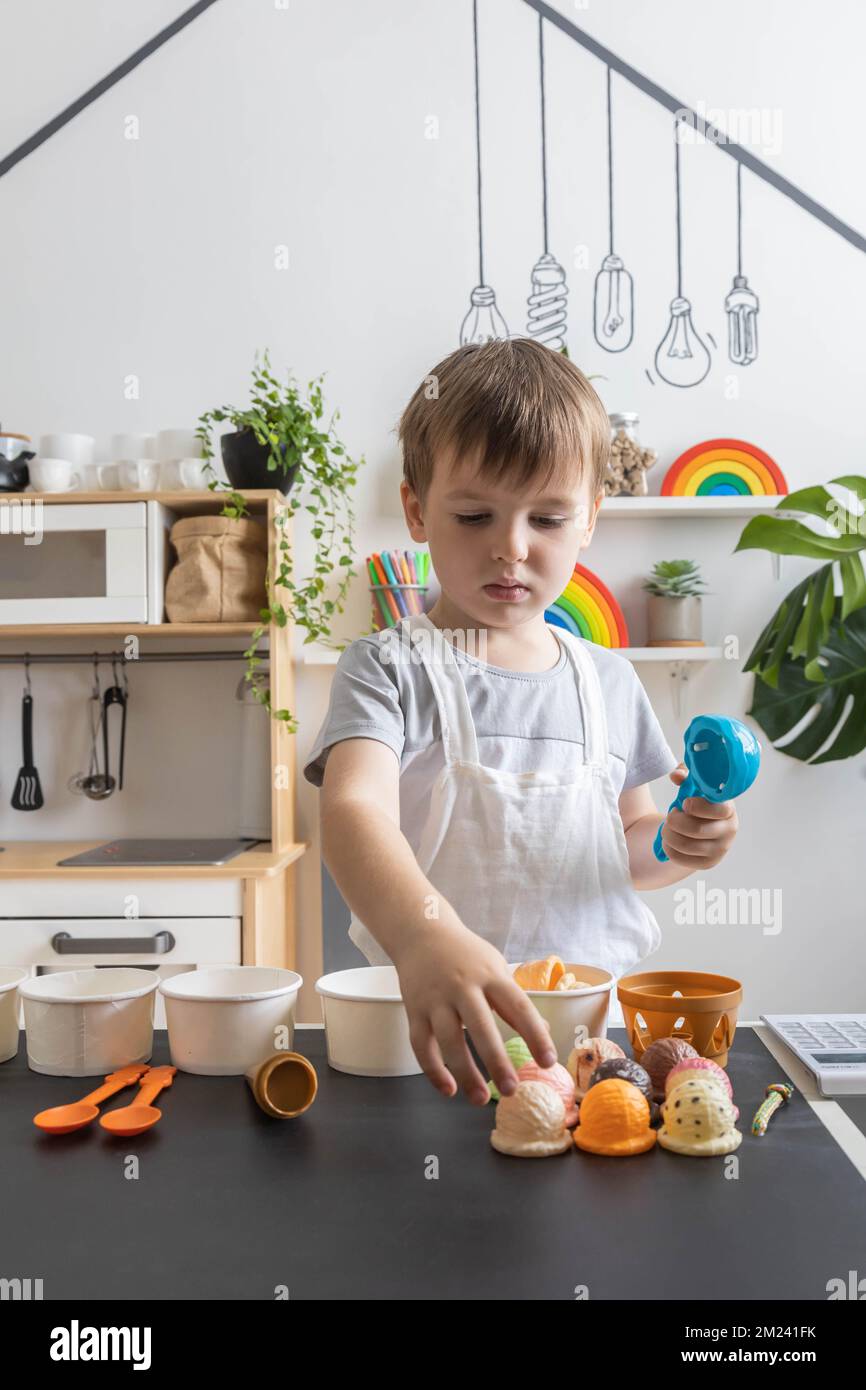 Baby boy playing cafe kitchen cashier payment counting use cash ...