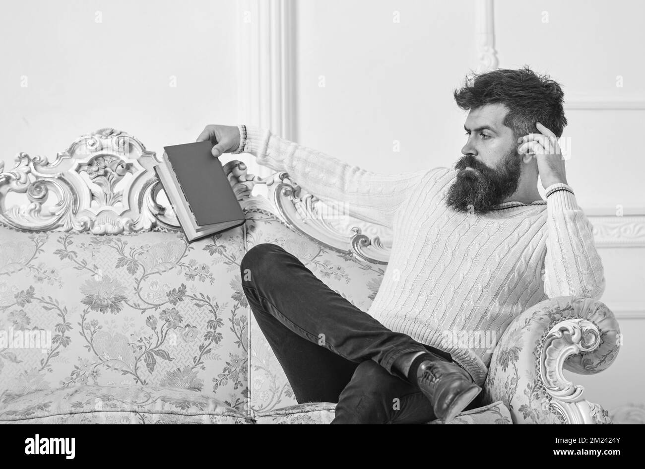 Man with beard and mustache spends leisure with book. Scientist ...