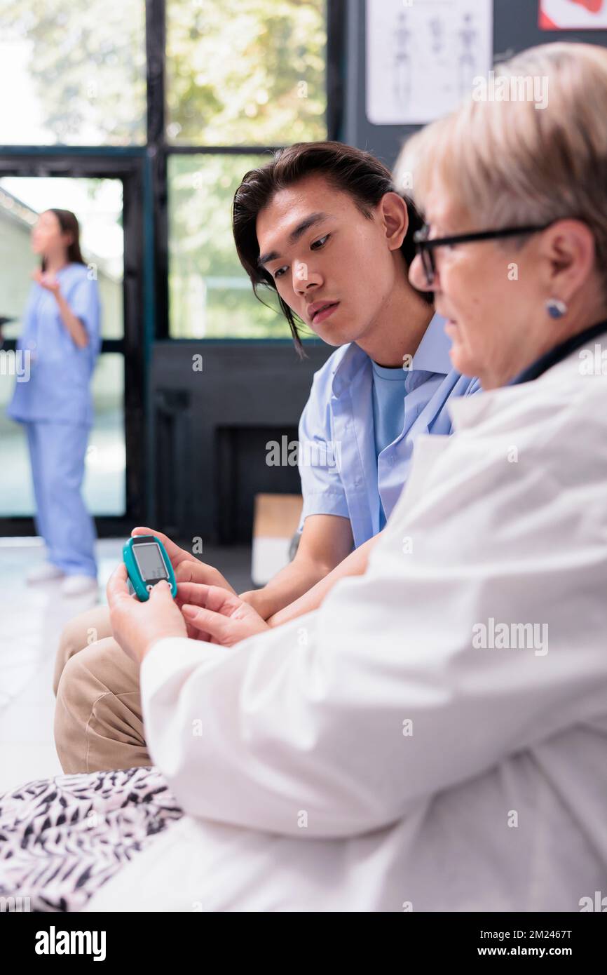 Senior physician medic measuring insulin level and glucose in blood ...