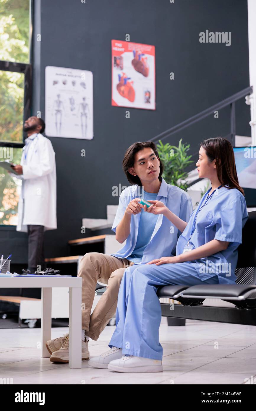 Nurse doing diabetes rutine control for asian patient using glucometer ...
