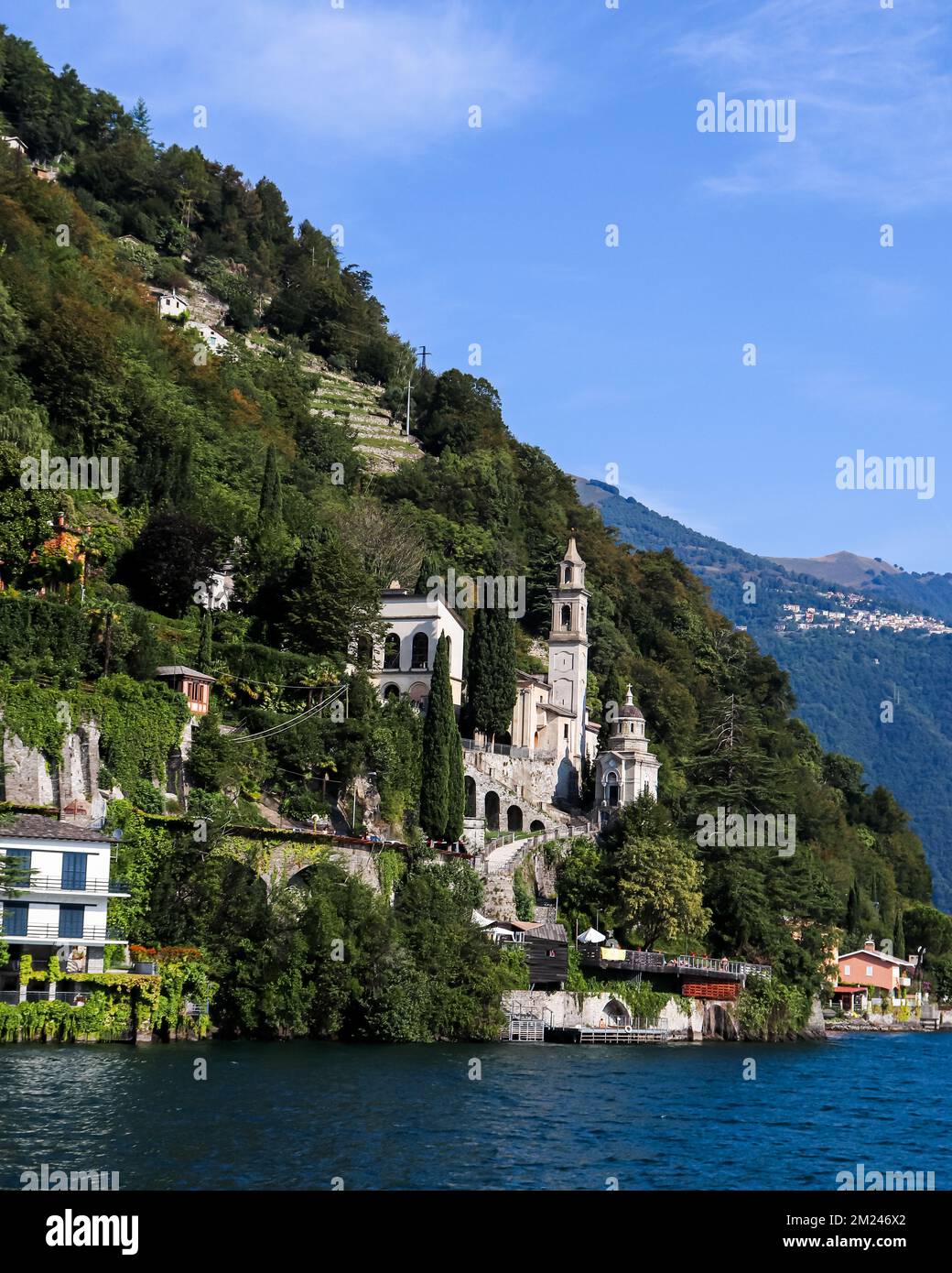 A vertical shot of historic buildings on the shore of Como Lake in ...