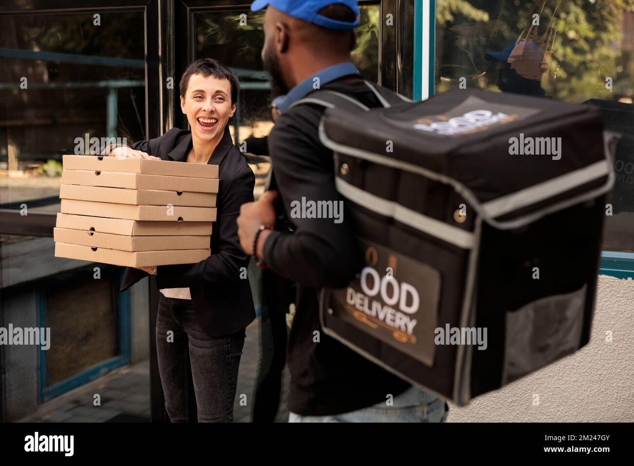Happy customer holding pizza boxes pile, receiving order from courier ...