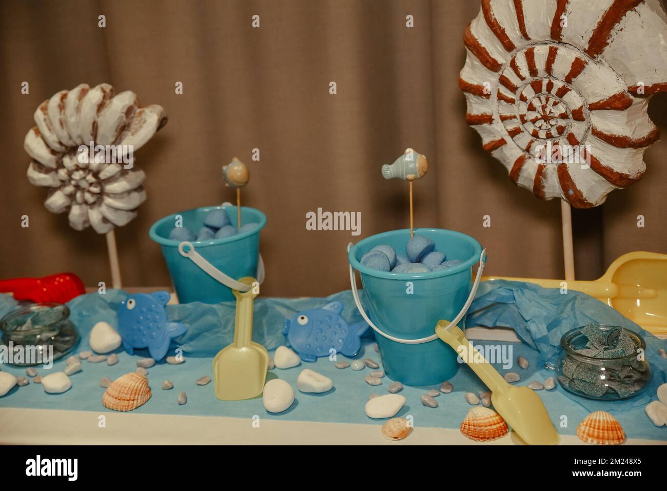 A closeup shot of decorations on a table at a beach-themed birthday ...