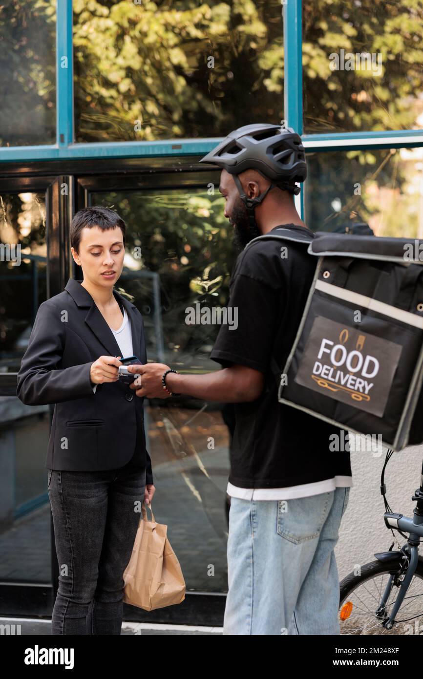 Office food delivery service, customer paying for lunch with credit ...