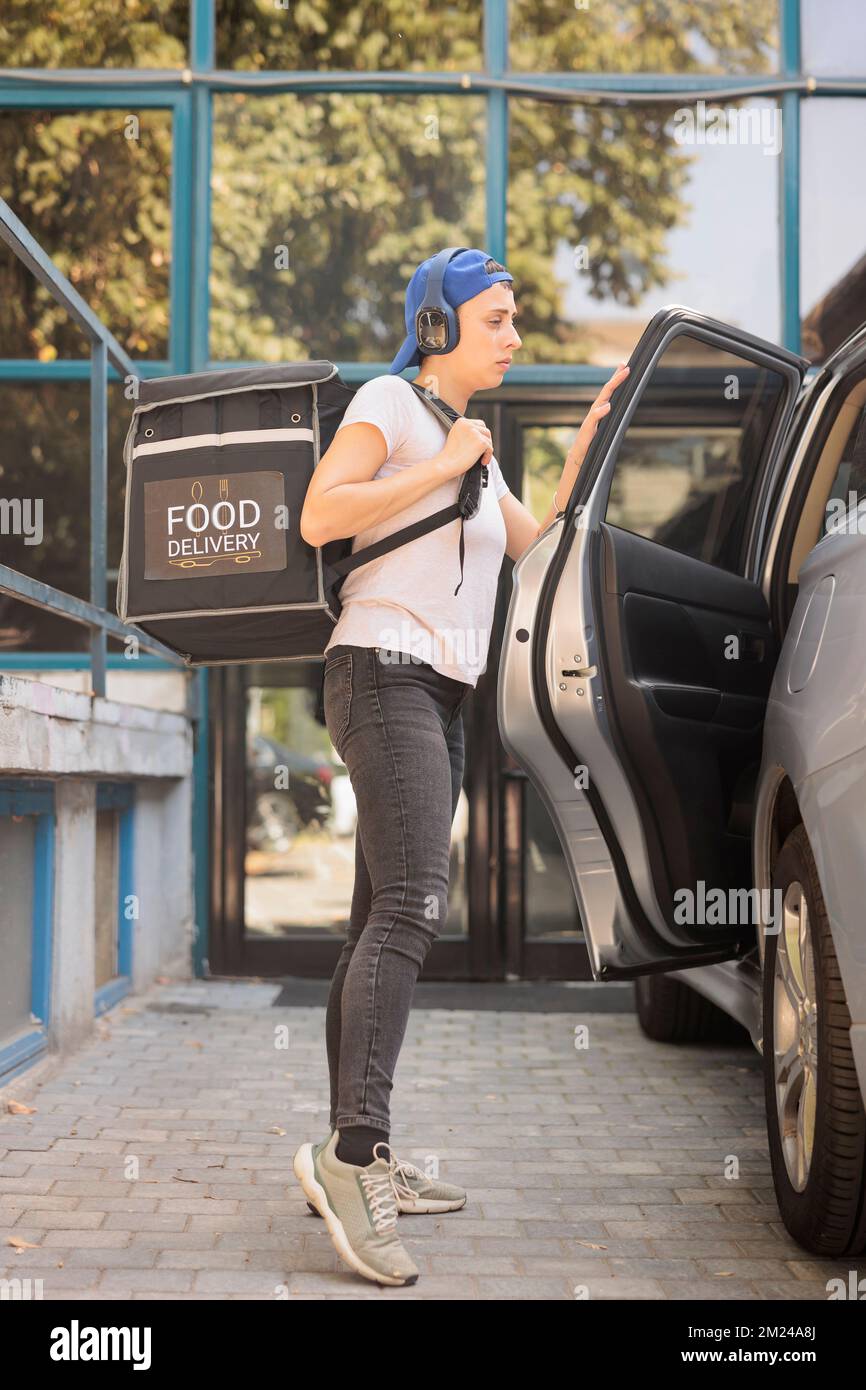 Takeaway food delivery service courier delivering office lunch by car ...