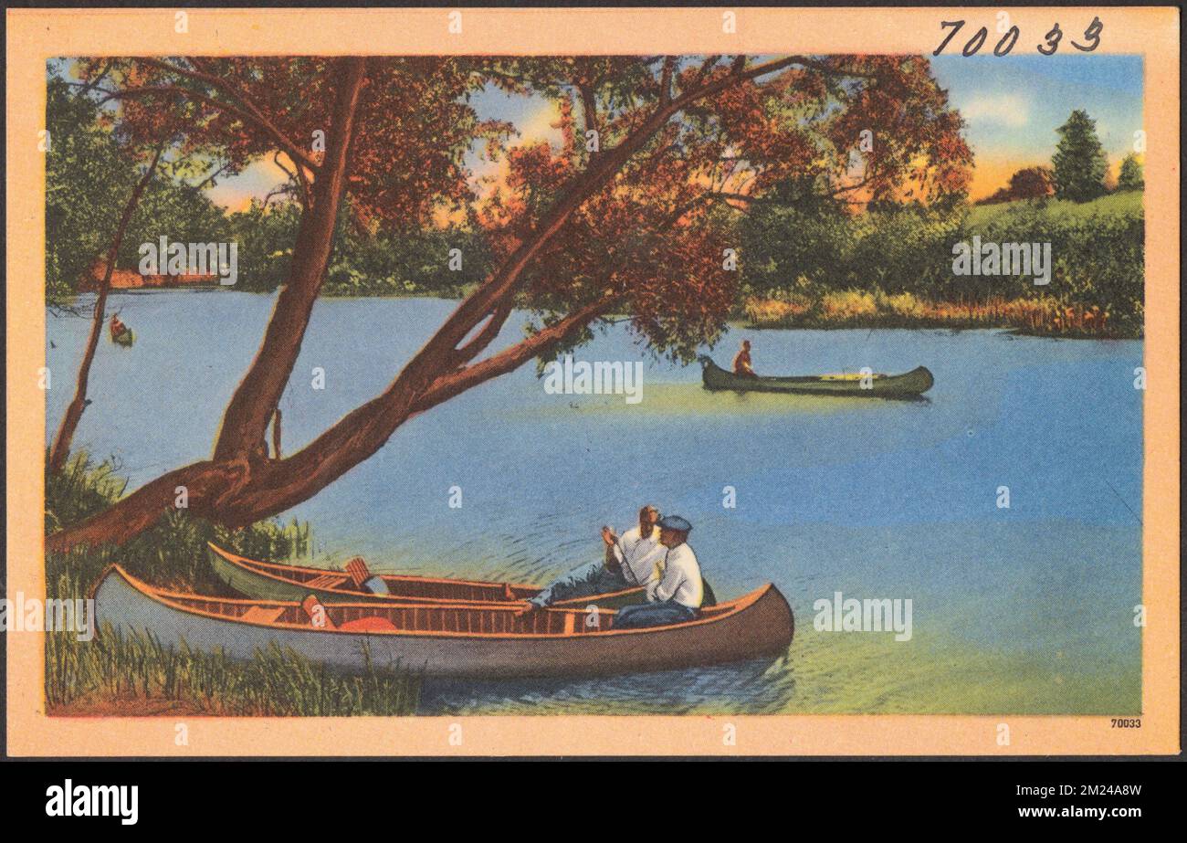 Canoe on a lake. Two other canoes are on the shore in the foreground ...