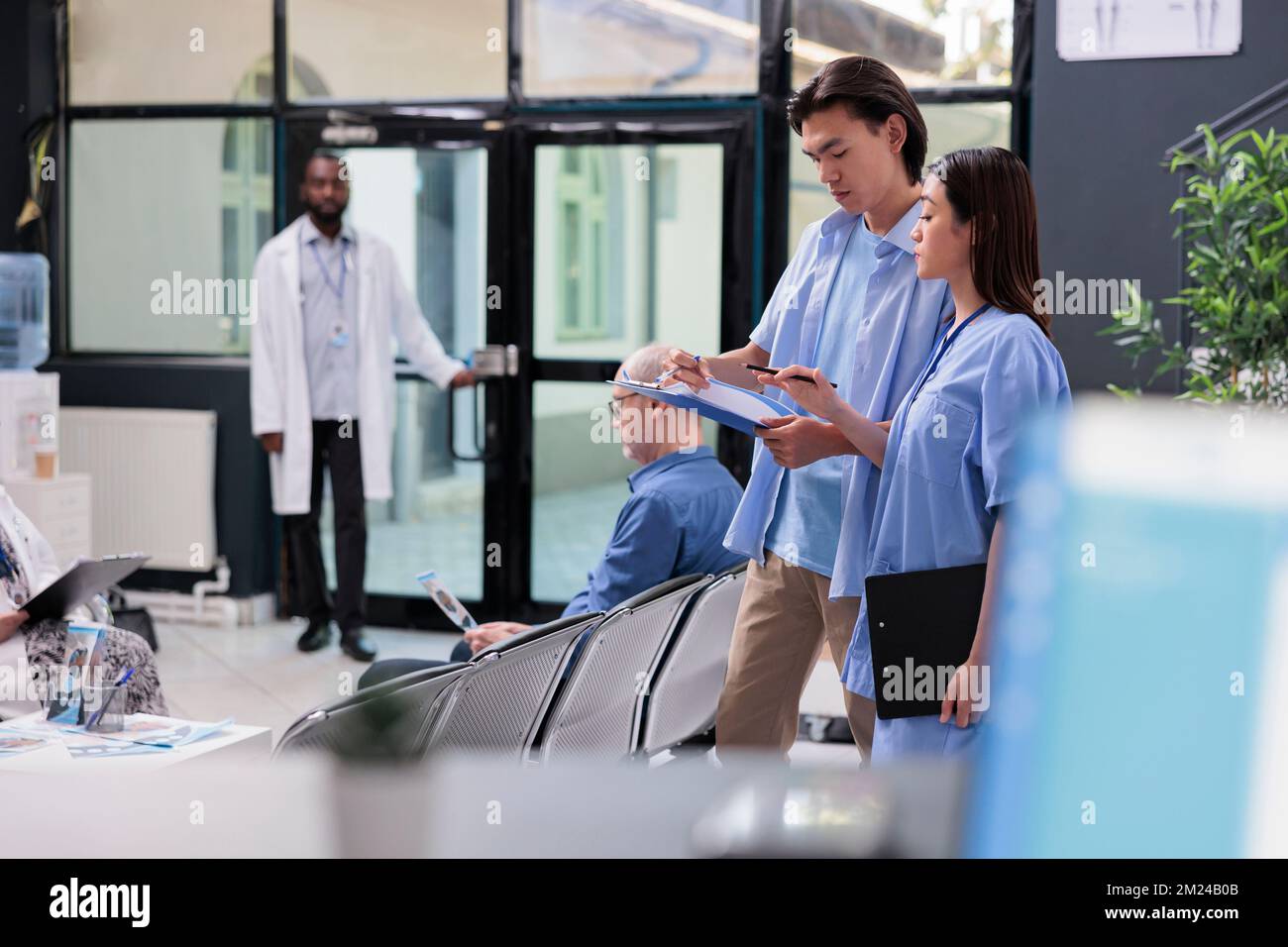 Asian young patient holding clipboard signing medical insurace before ...