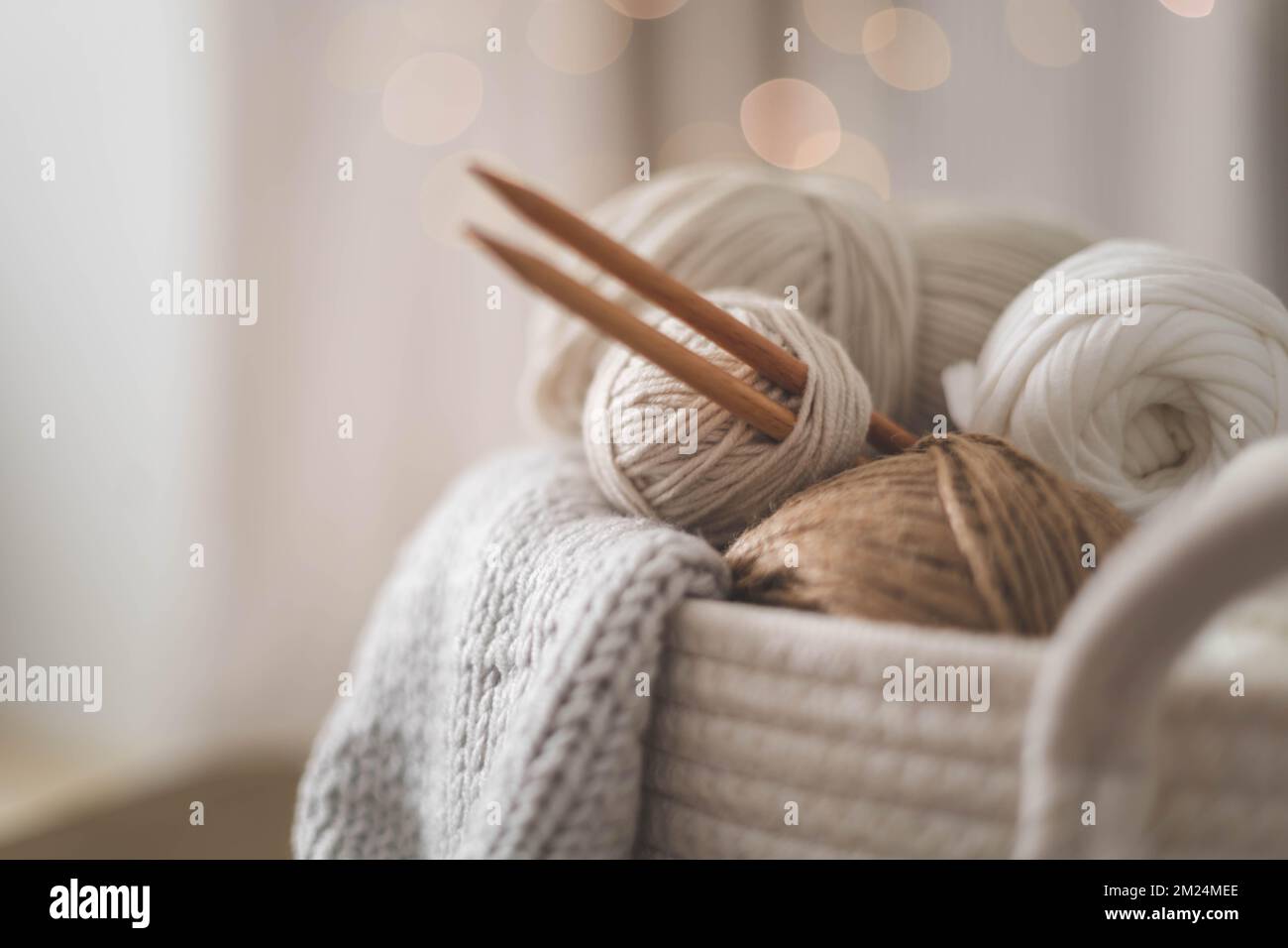 Cozy homely atmosphere. Female hobby knitting. Yarn in neutral shades ...