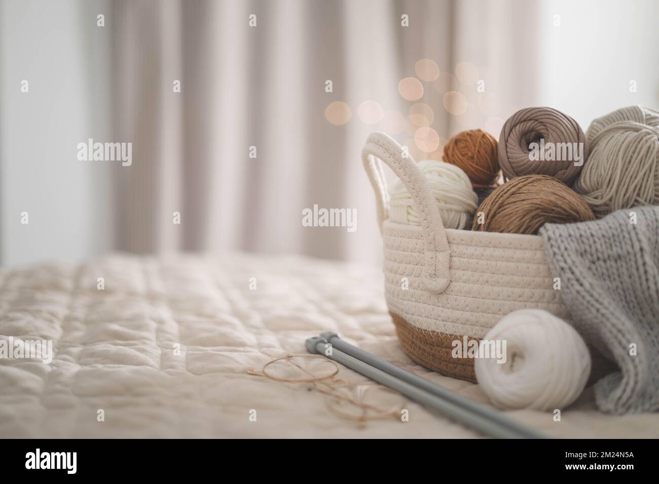 Cozy homely atmosphere. Female hobby knitting. Yarn in neutral shades ...