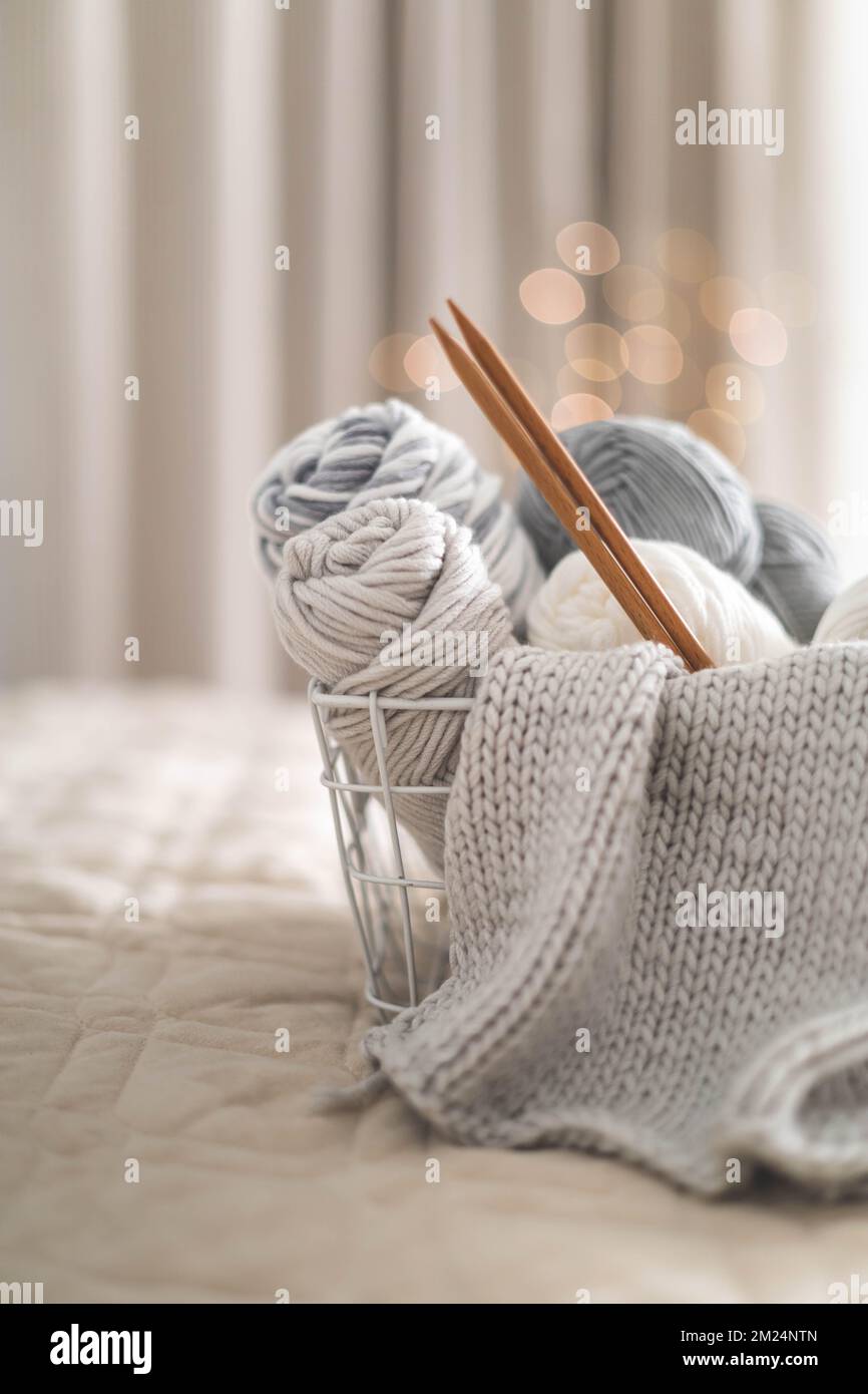 Cozy homely atmosphere. Female hobby knitting. Yarn in neutral colors ...