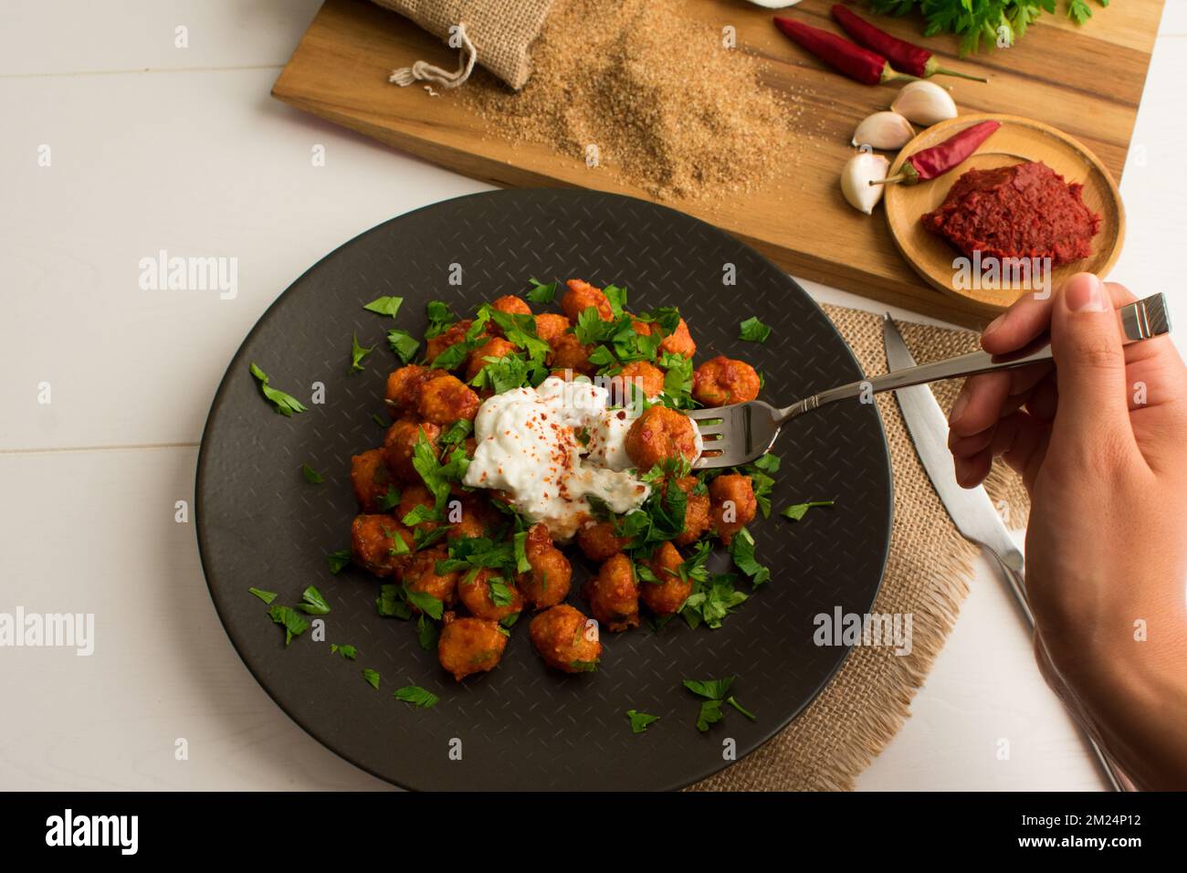 Traditional Turkish food “Fellah Kofte” , bulgur meatballs with tomato ...