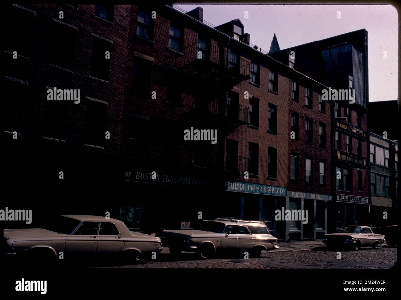 Cars parked on street in front of row of buildings, Boston ...