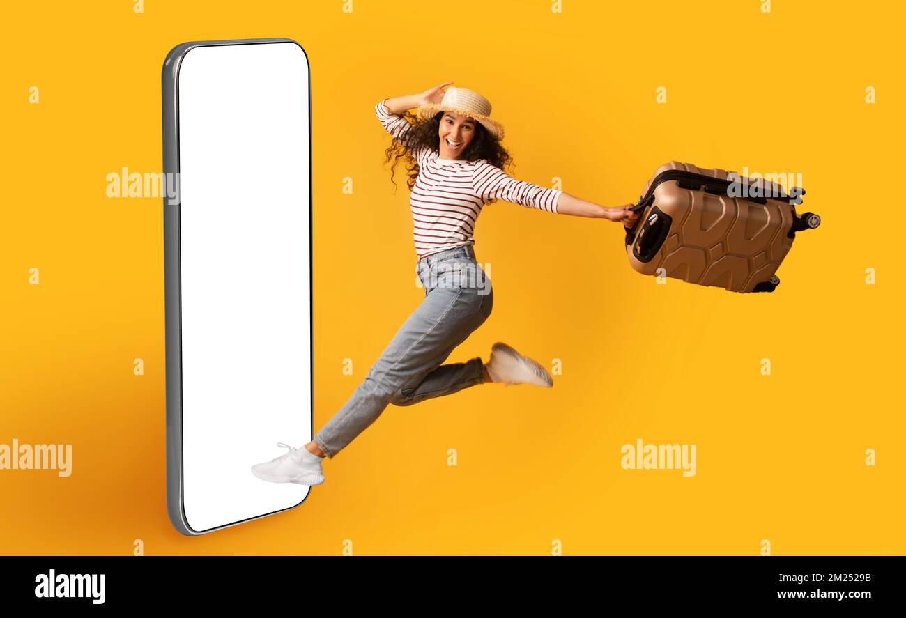 Emotional brunette woman tourist running towards smartphone with mockup ...