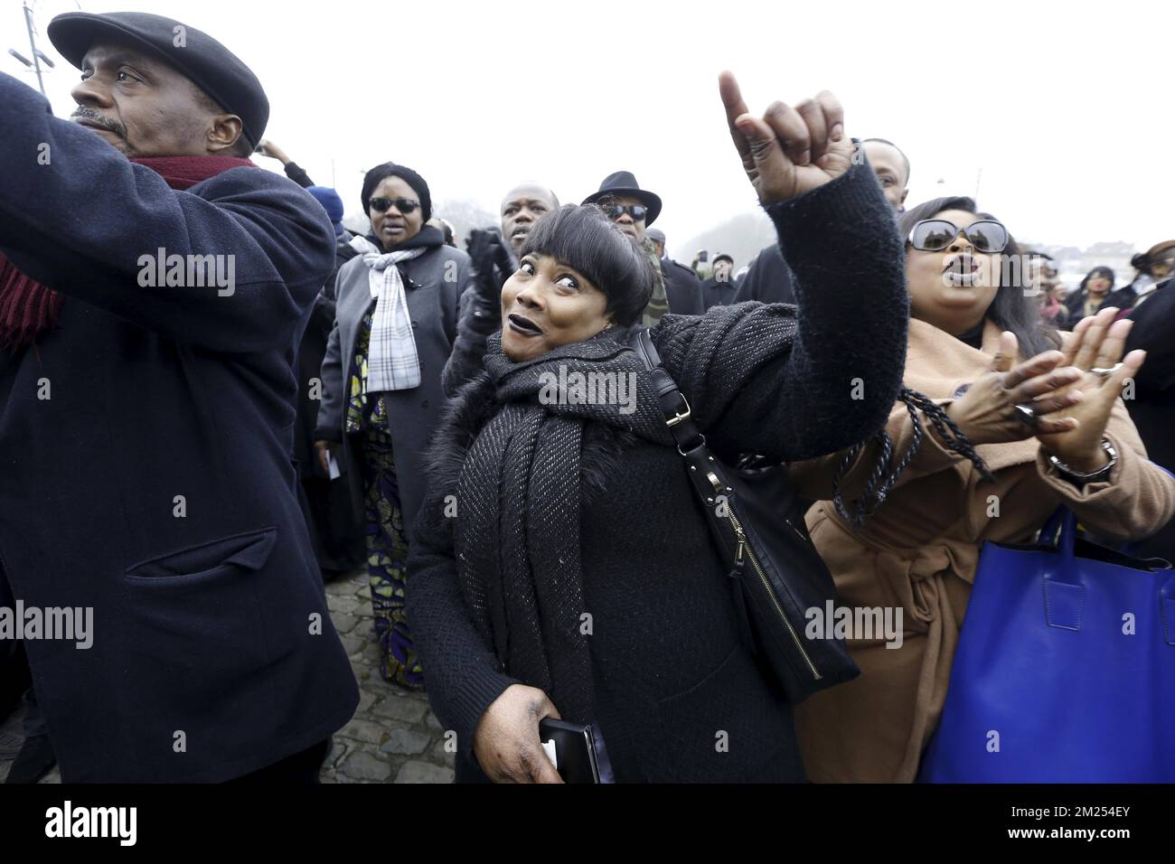 Lots of people of the Congolese community surrounded the hearse with ...