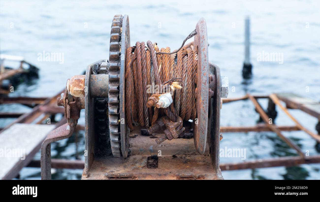 Rusty chains and rope. rope winding machine. nautical instruments ...