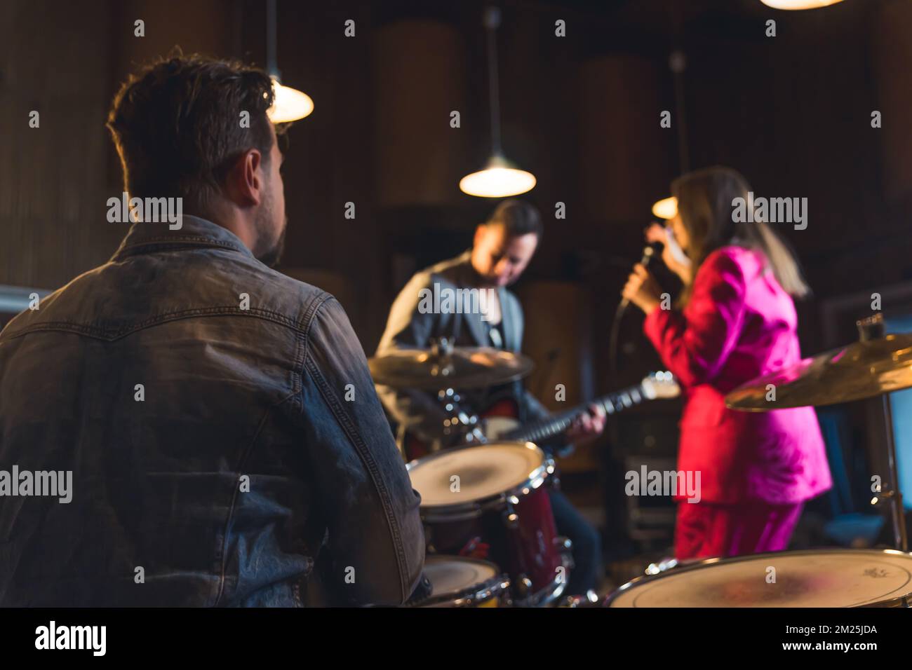 Drummer's view during a concert of rehearsal. Back view of male drummer ...