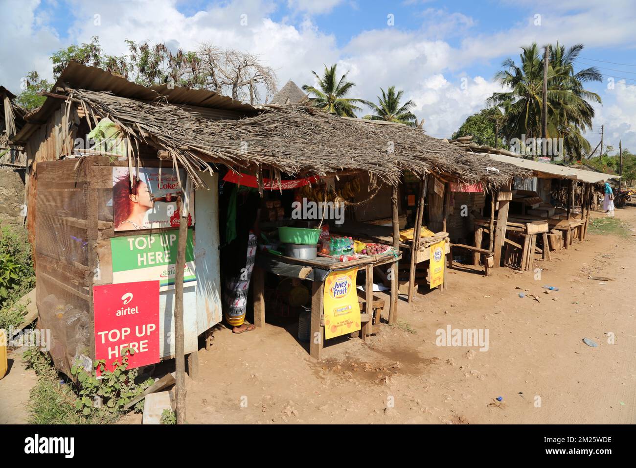 A line of African poor shops on dirt road in Ukunda, Kenya Stock Photo ...