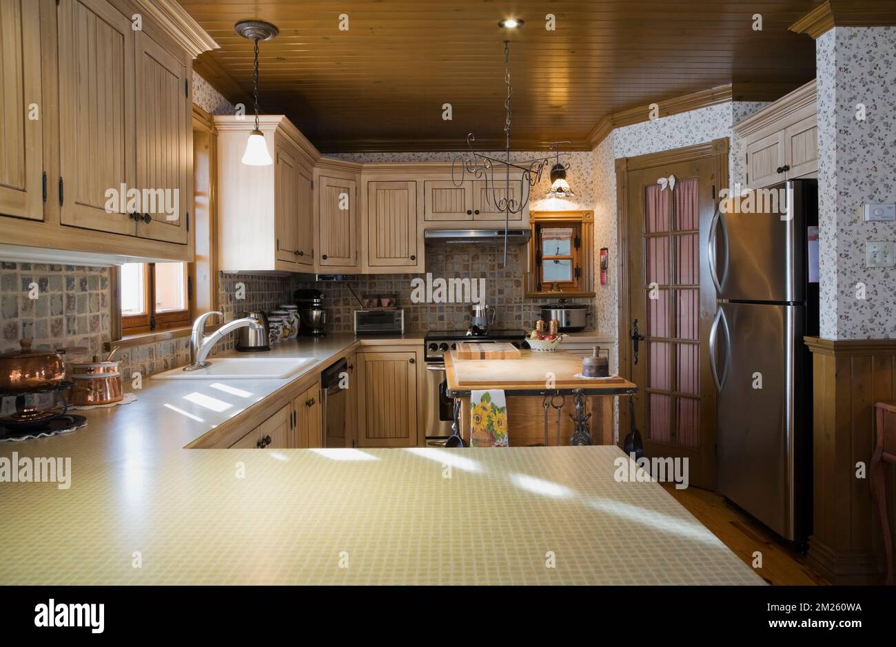 Bleached cabinets, countertops and island in country style kitchen ...