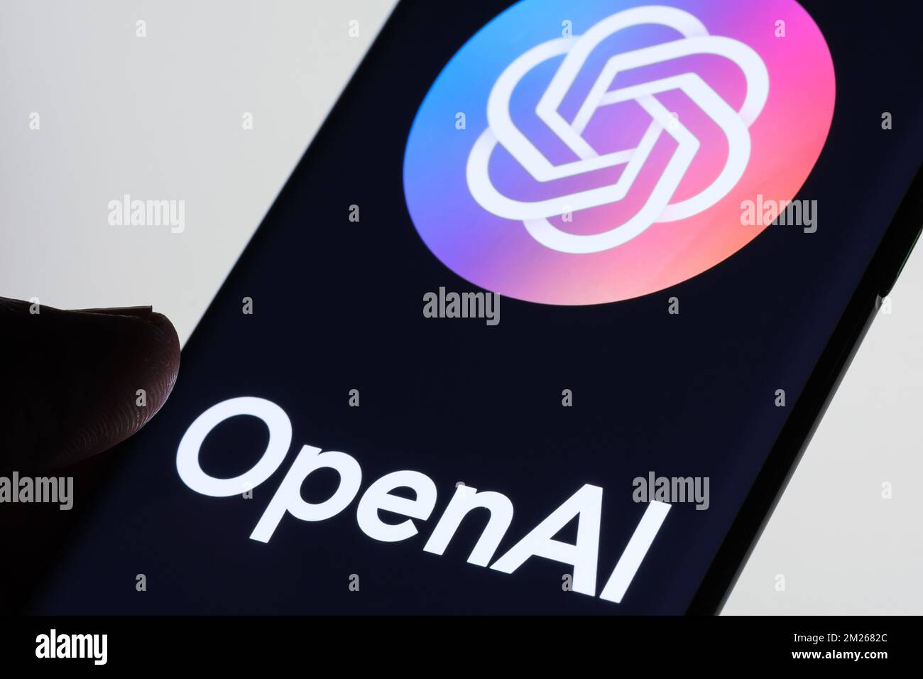 OpenAI logo seen on the screen of smartphone. AI software developer. Stafford, United Kingdom ...