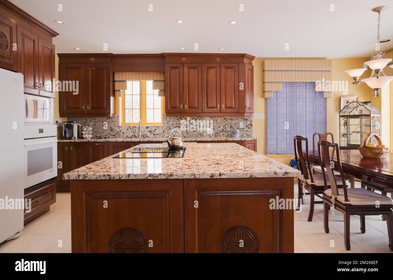 Contemporary brown stained kitchen cabinets and island with nuanced ...