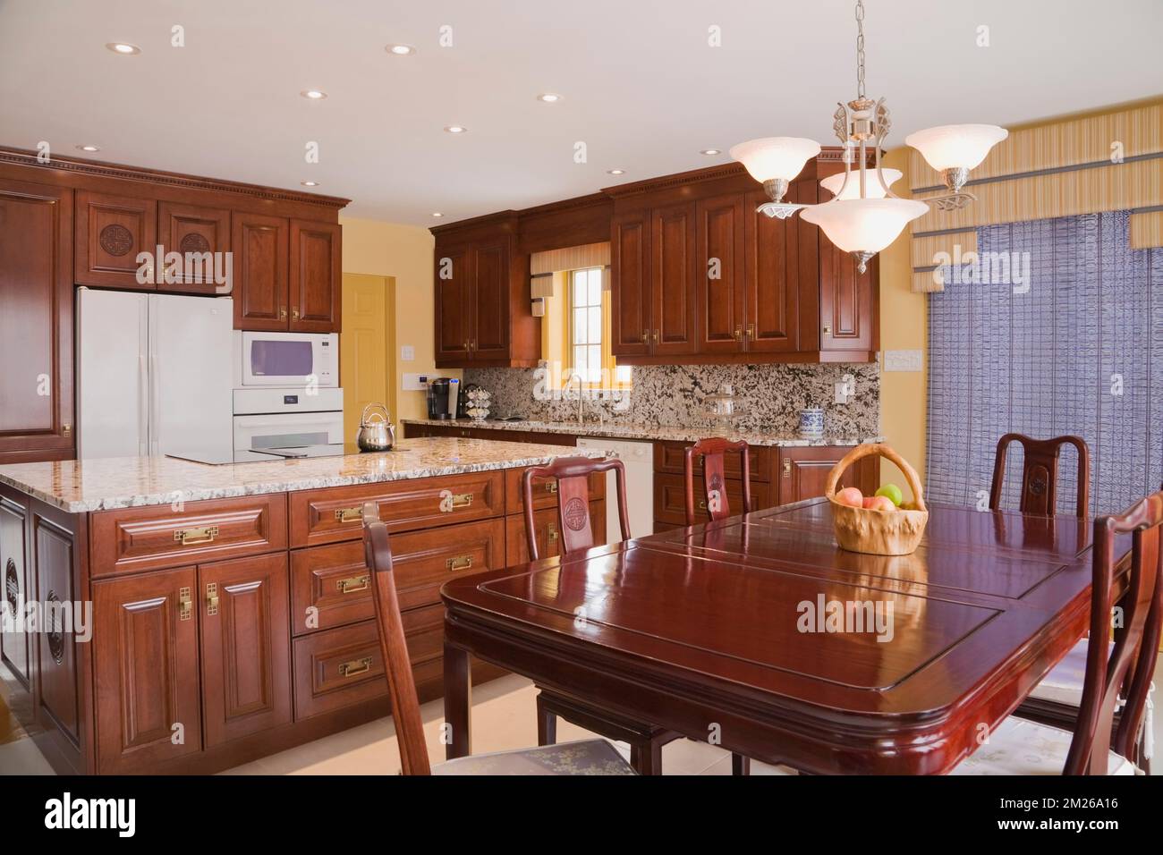 Contemporary brown stained kitchen cabinets and island with nuanced ...
