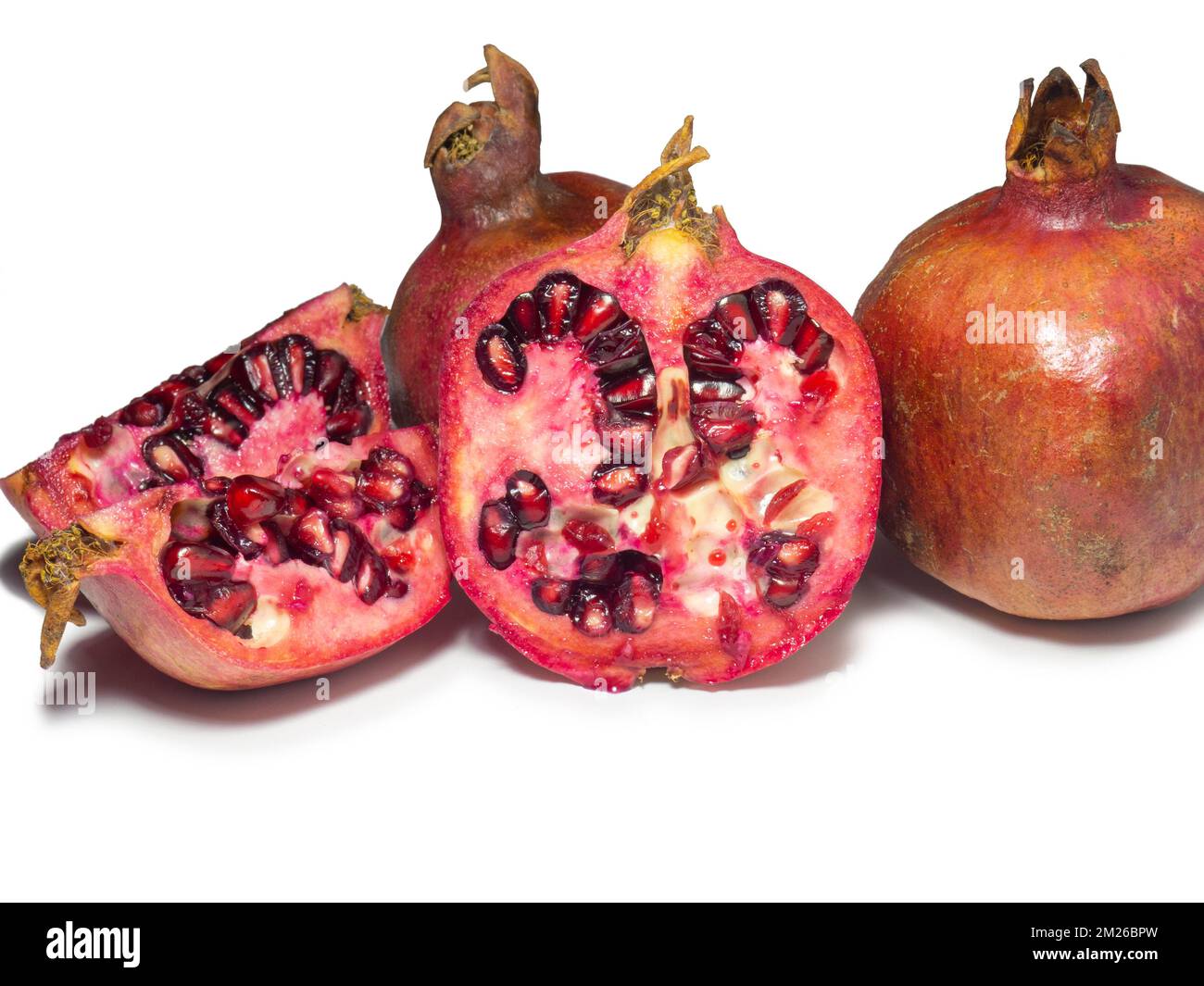 Sliced pomegranate on a white background. Juicy fruit with seeds ...