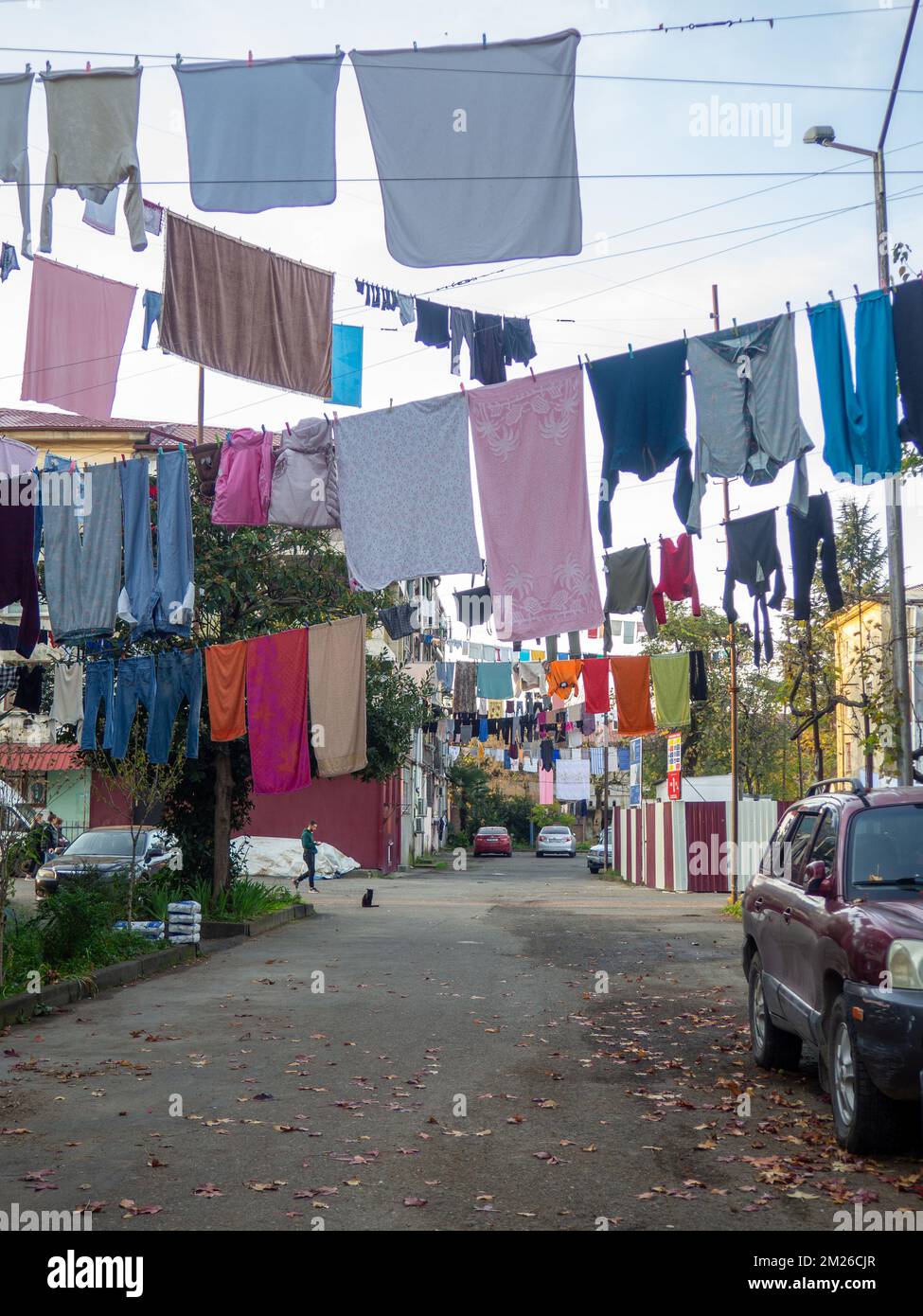 People in the yard. laundry is dried on clothesline. City environment ...