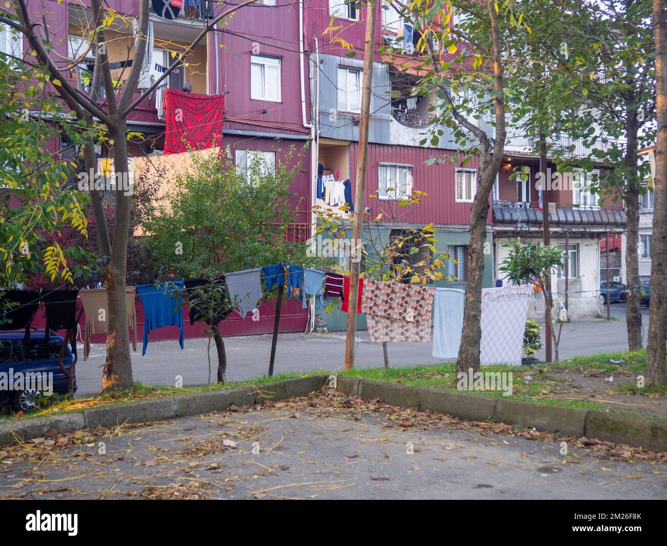 People in the yard. laundry is dried on clothesline. City environment ...