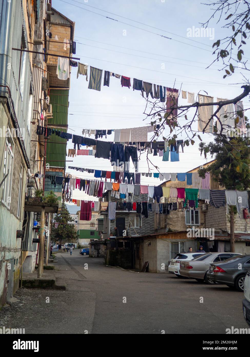 laundry is dried on clothesline. City environment. Asian city streets ...