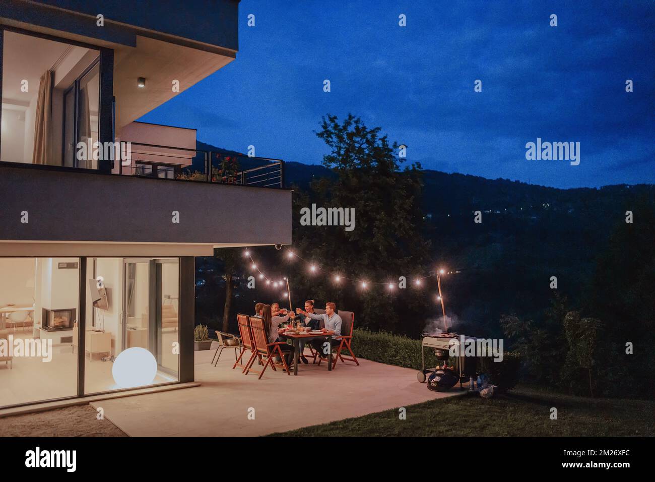 A group of young diverse people having dinner on the terrace of a ...