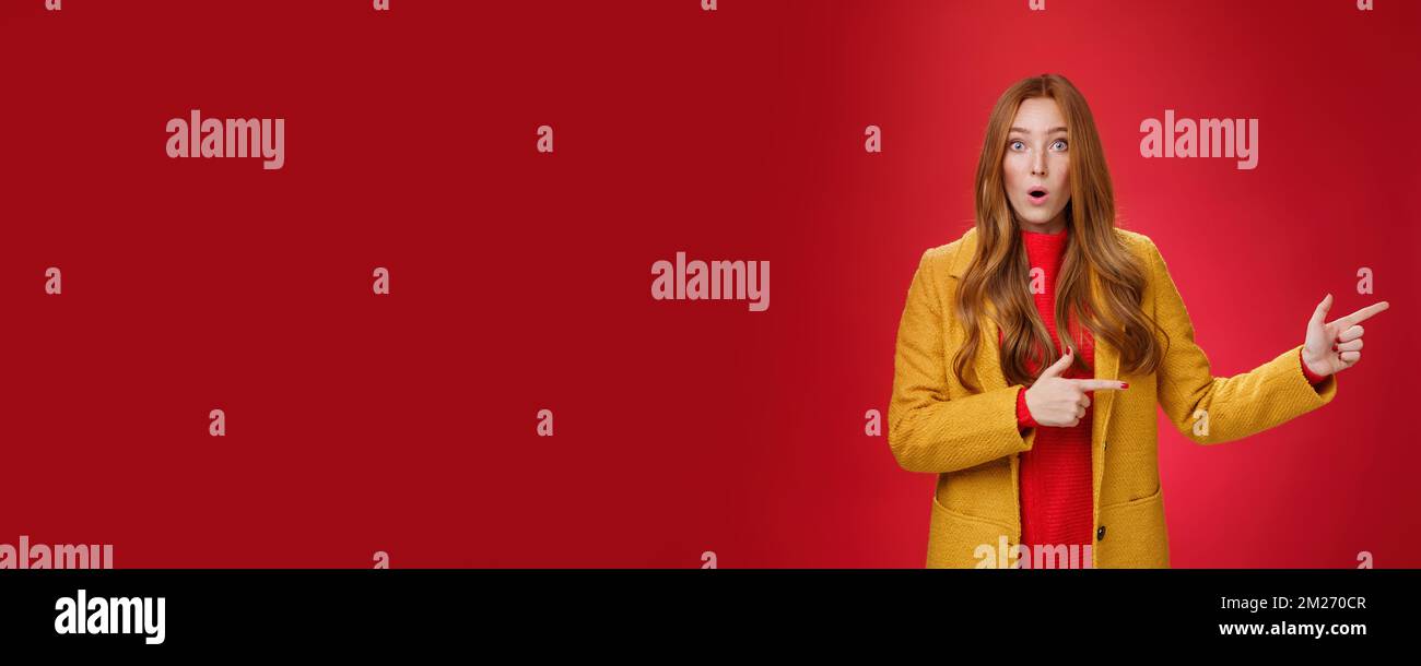 Speechless questioned and confused surprised redhead girl in yellow ...