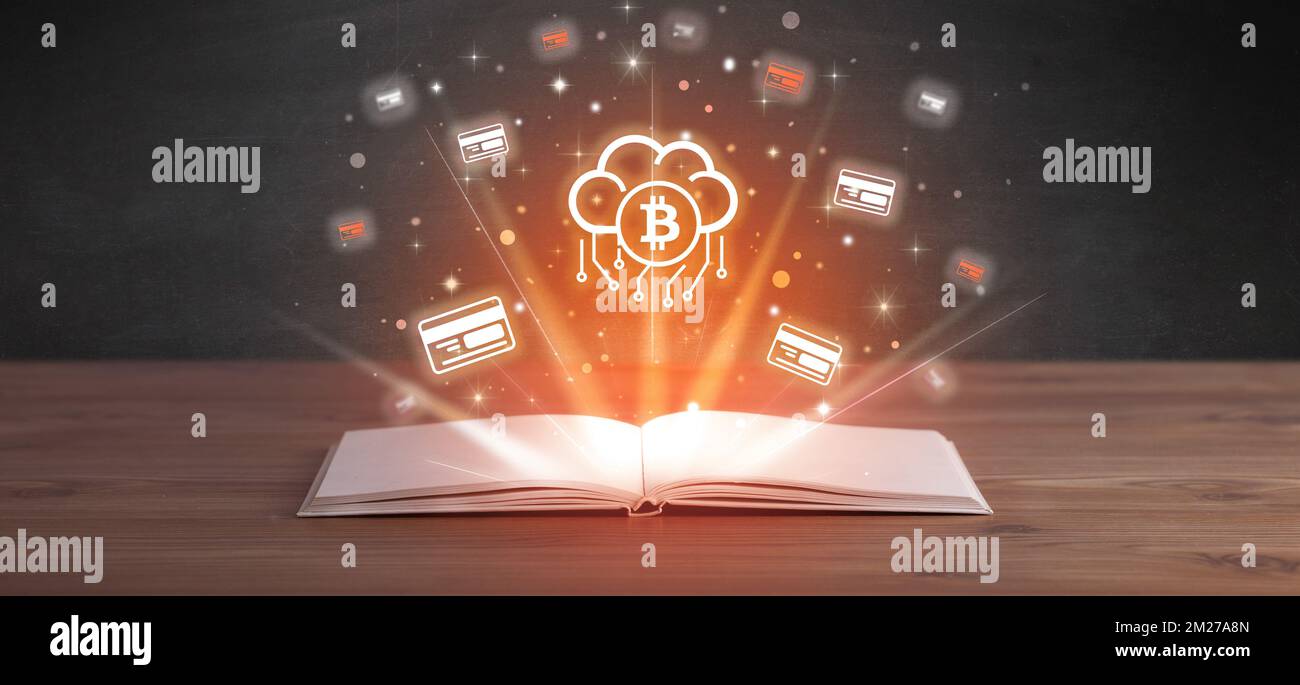 Open book with currency icons above Stock Photo - Alamy